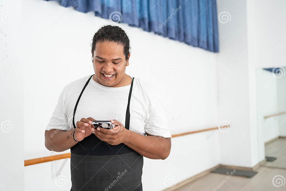 Male Ballet Dancer Smiling Using a Phone in a Ballet Dance Studio Stock ...