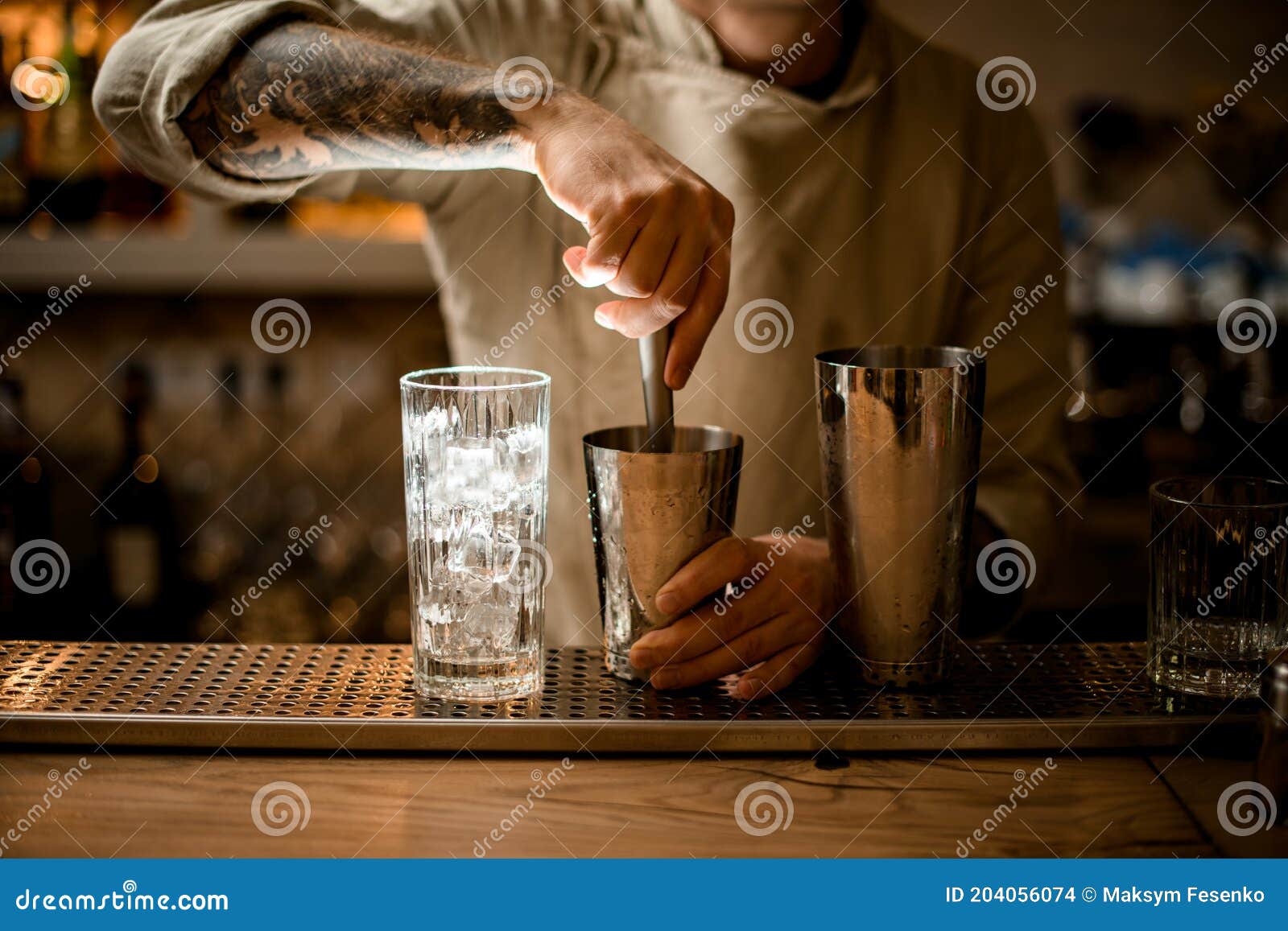 Male Bartender Prepares Cocktail in Shaker Cup Using the Muddler Stock ...