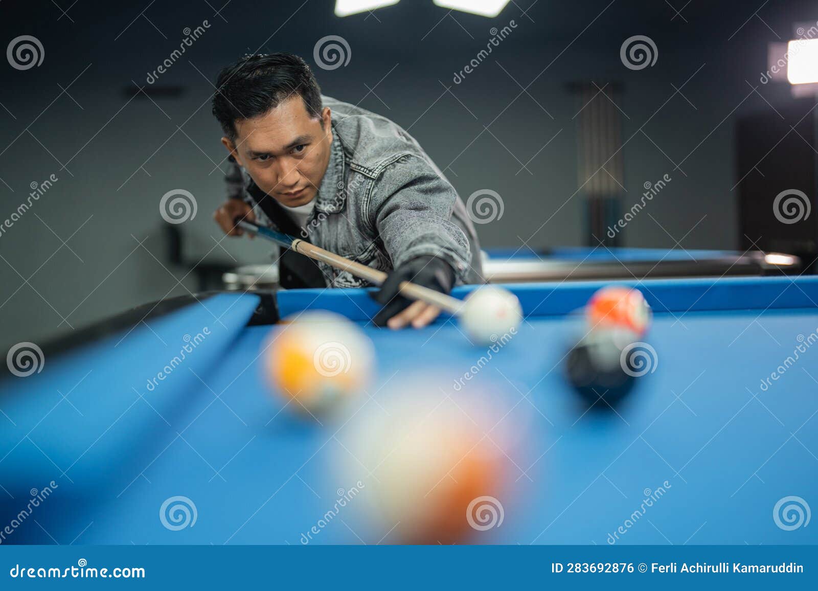 Male Billiard Player Poking the Ball Seriously Using the Cue Stick ...