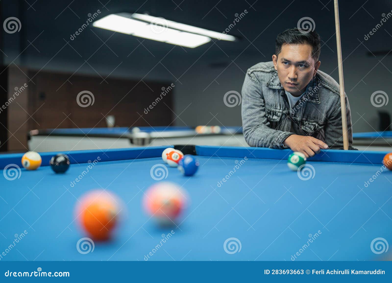 Male Billiard Player Poking the Ball Seriously Using the Cue Stick ...
