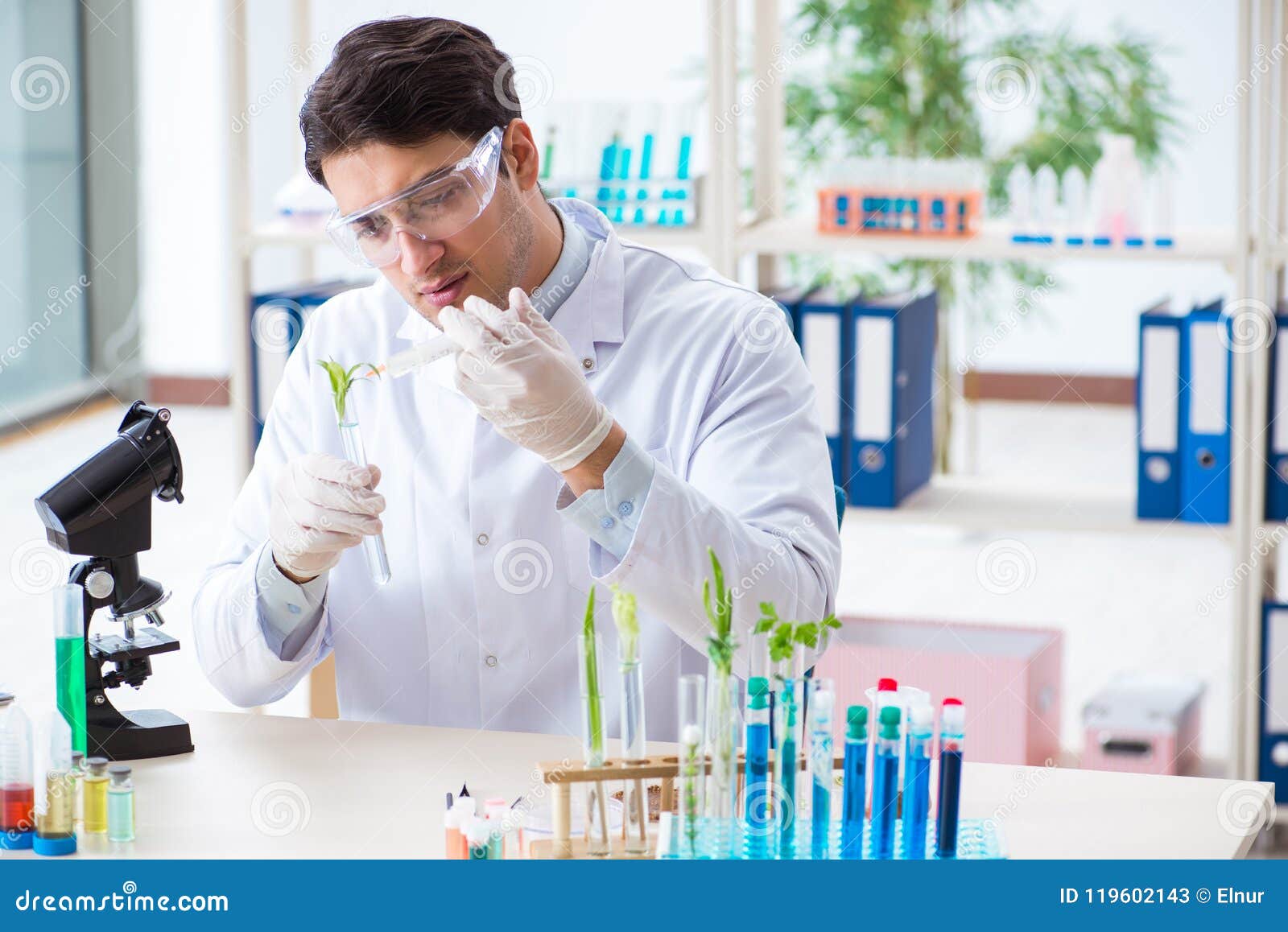 The Male Biochemist Working in the Lab on Plants Stock Image - Image of ...