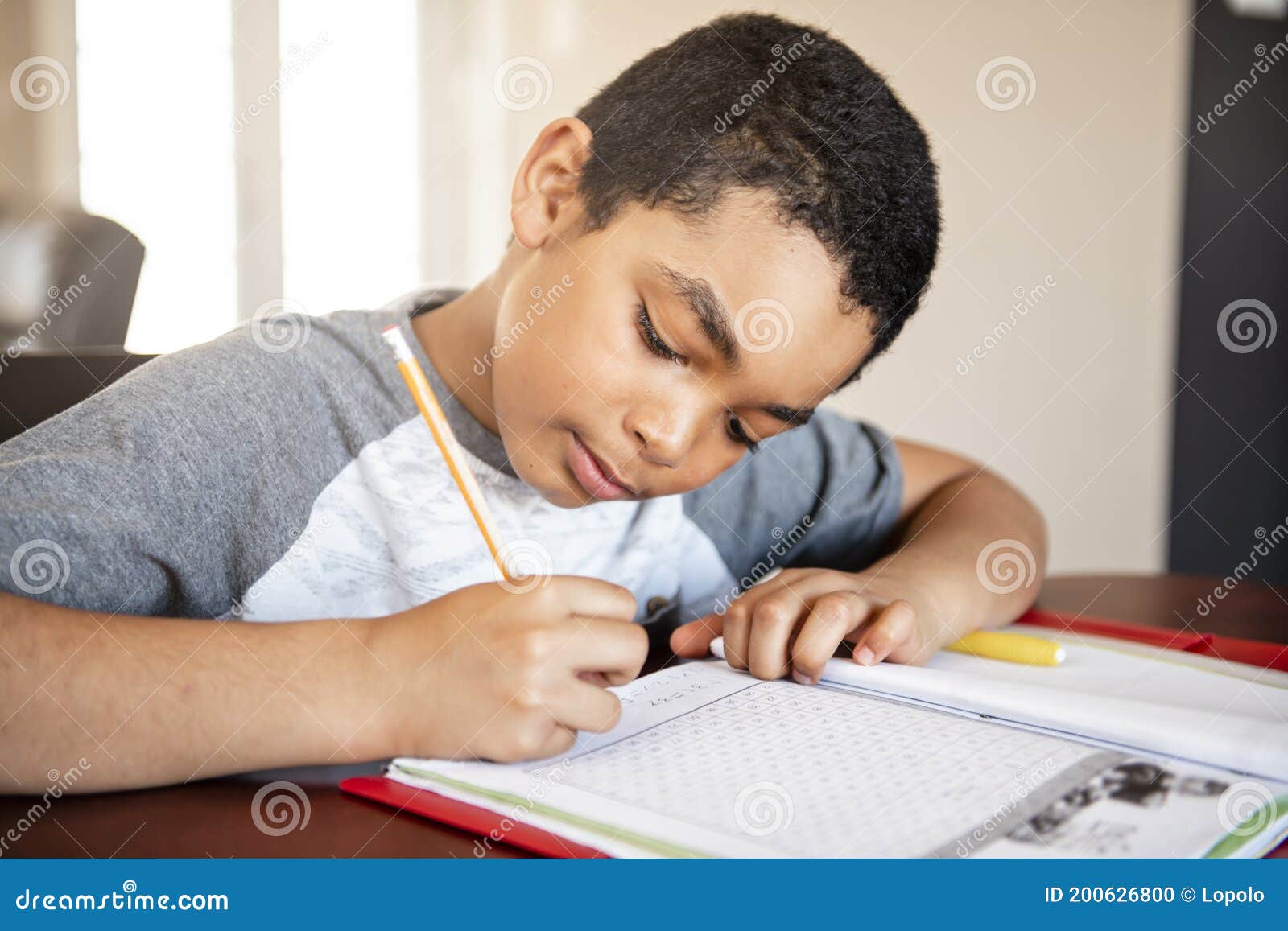 A Male Black Child Doing Homework at Home Stock Photo - Image of paper ...