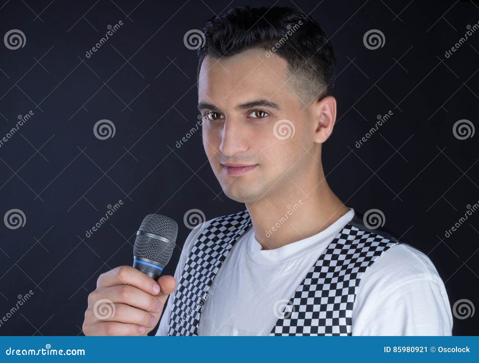 Male Black-haired Pop Singer Performs Singing To Microphone Stock Image ...