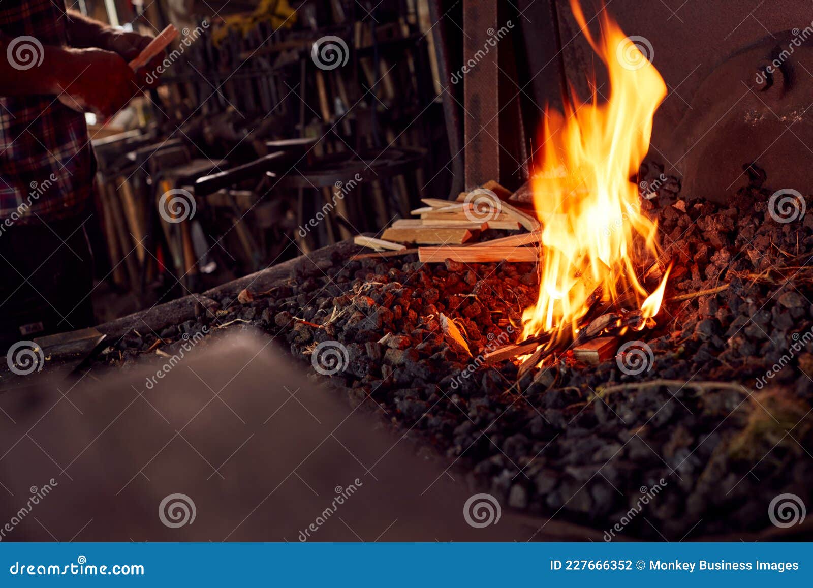 Male Blacksmith Lighting Wood Kindling To Start Blaze in Forge Stock ...