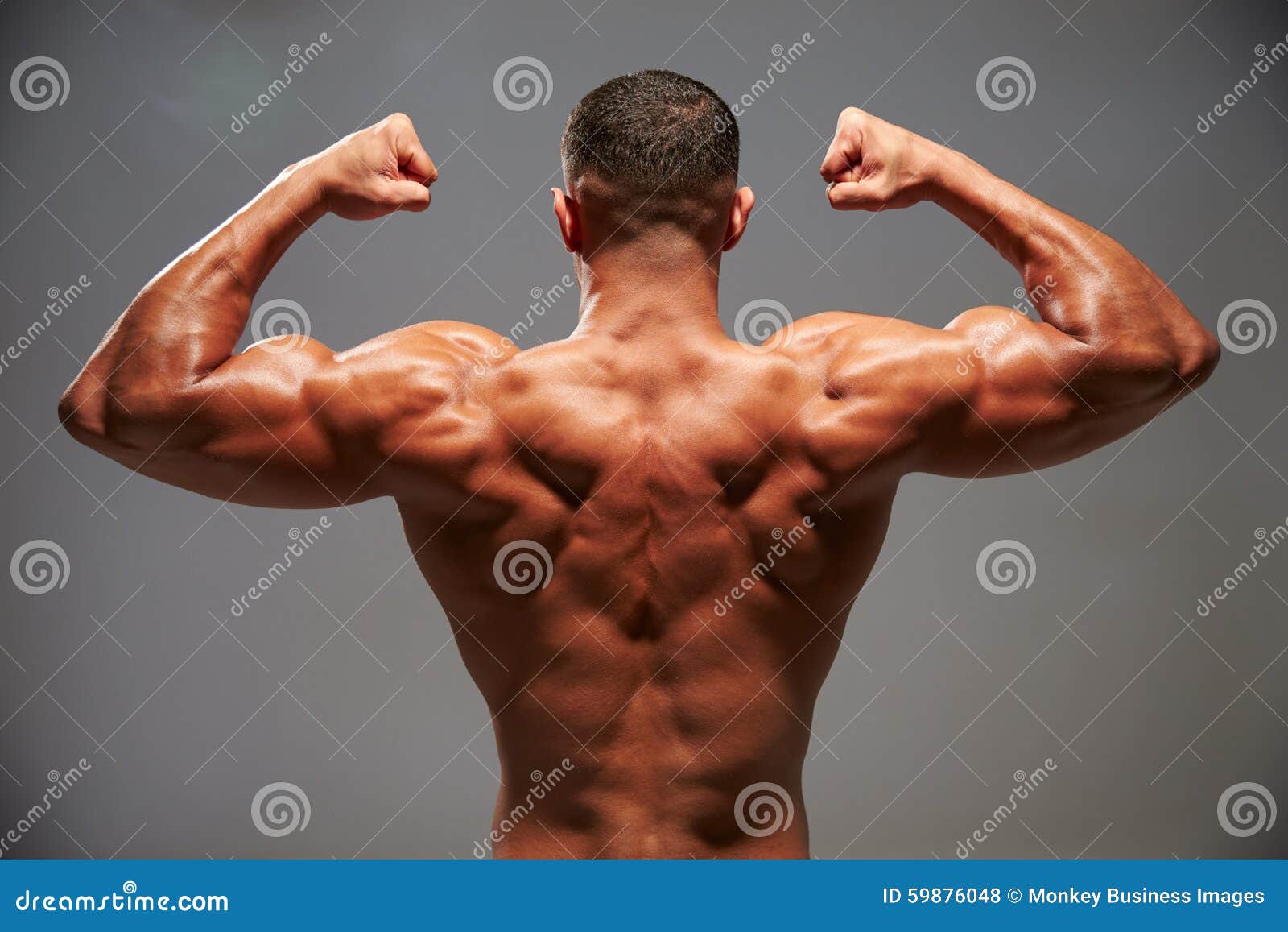 Male Bodybuilder Flexing His Biceps, Back View Stock Photo - Image of ...