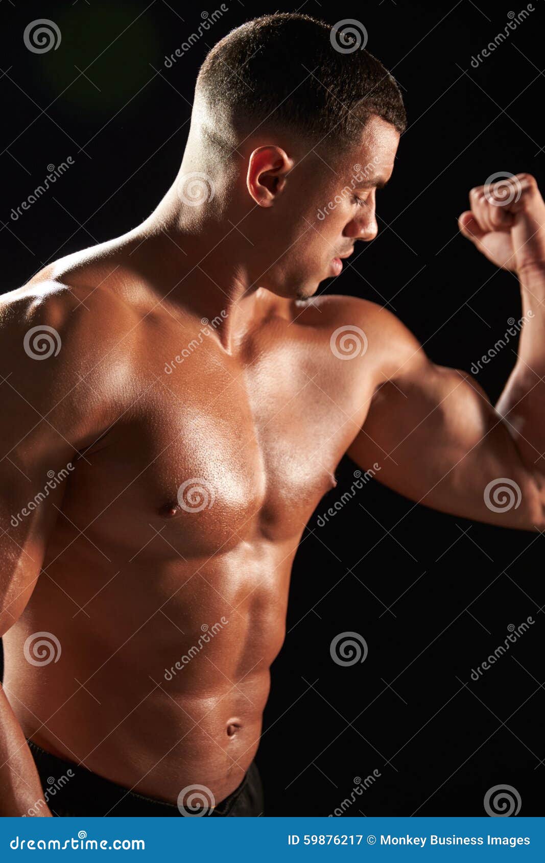 Male Bodybuilder Looking at His Flexing Muscles, Close-up Stock Image ...