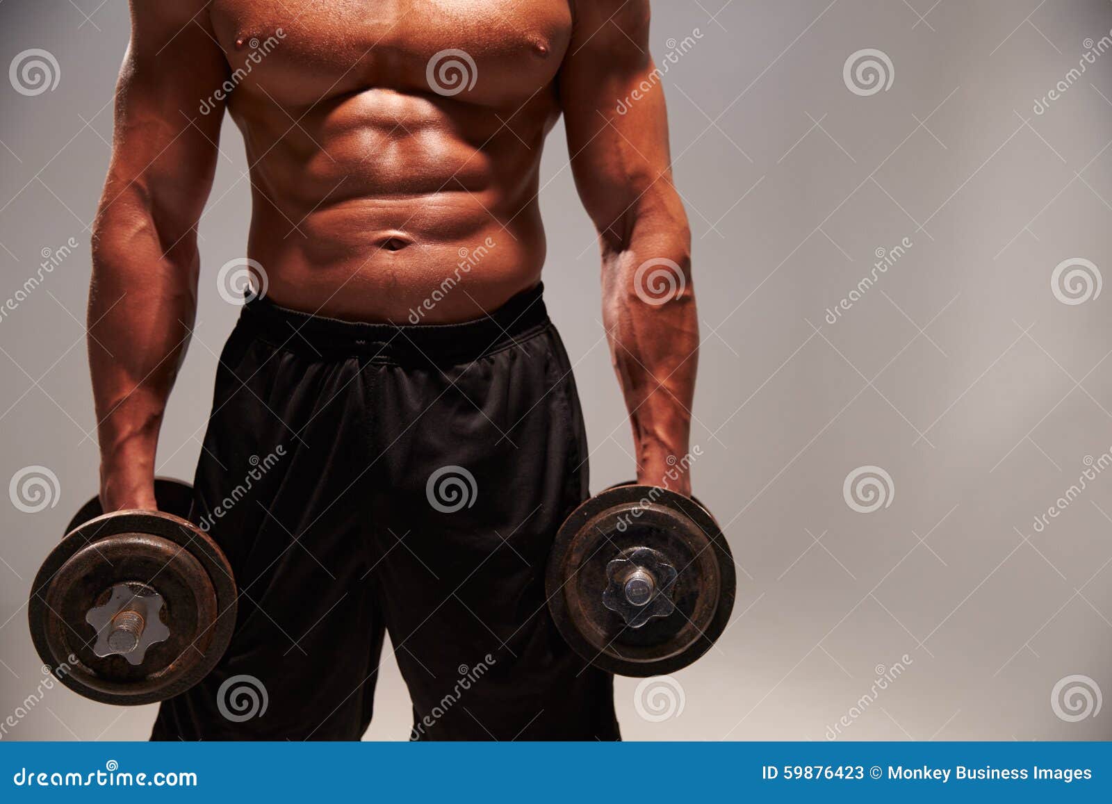 Male Bodybuilder Working Out with Heavy Dumbbells, with Copy Space ...