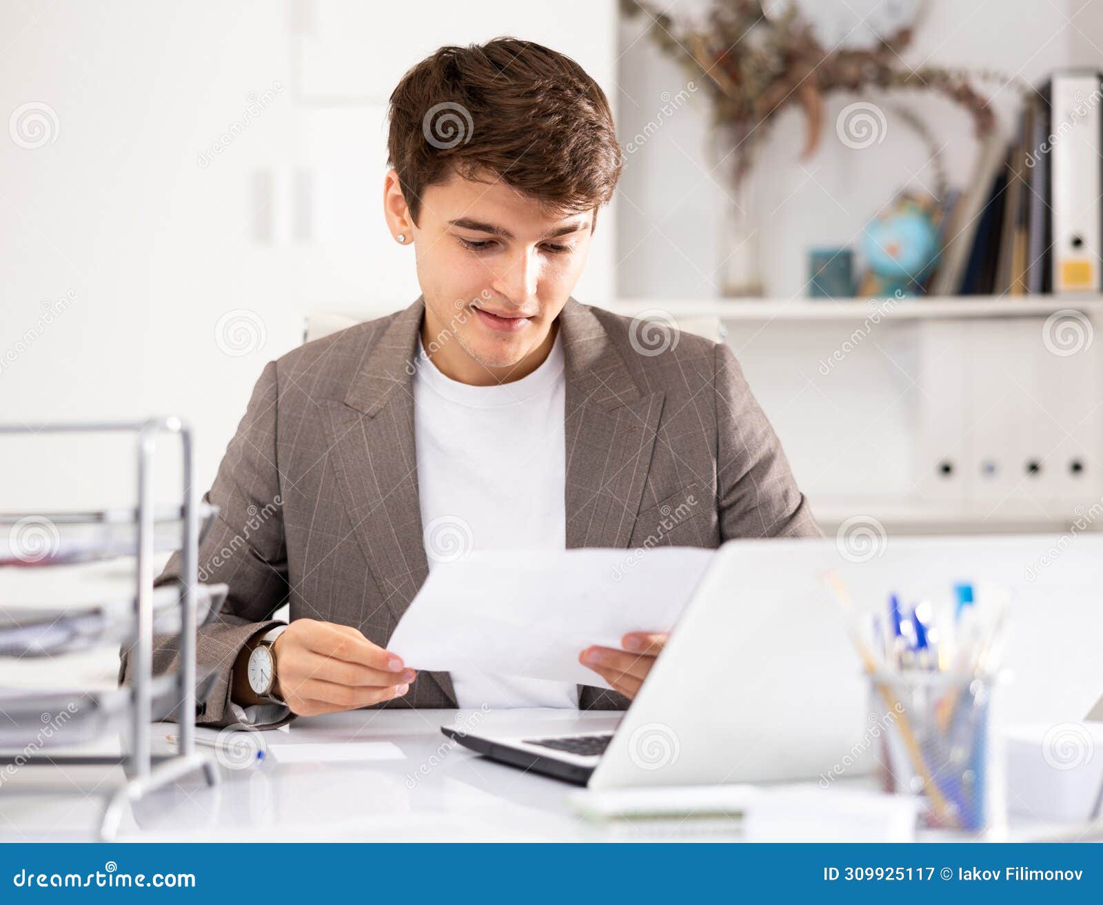 Male Bookkeeper Doing Paperwork in Workplace in Office - Checks ...