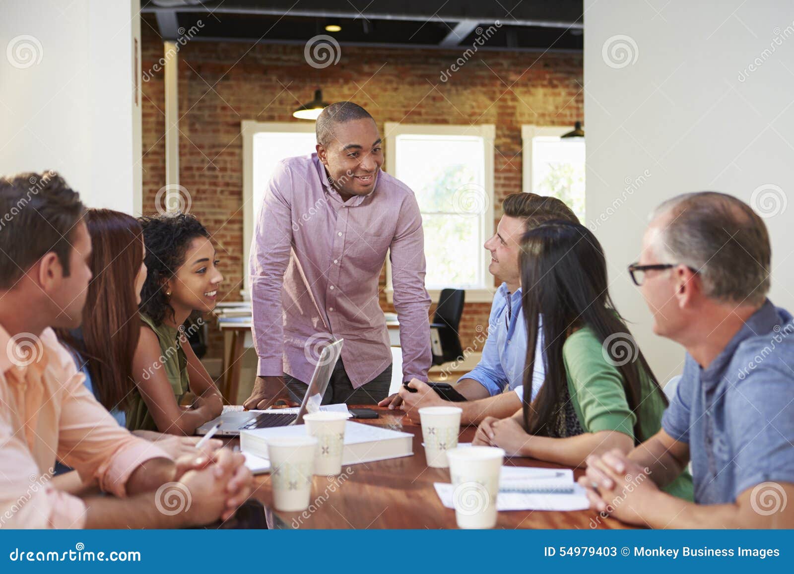 Male Boss Addressing Office Workers At Meeting Royalty-Free Stock ...