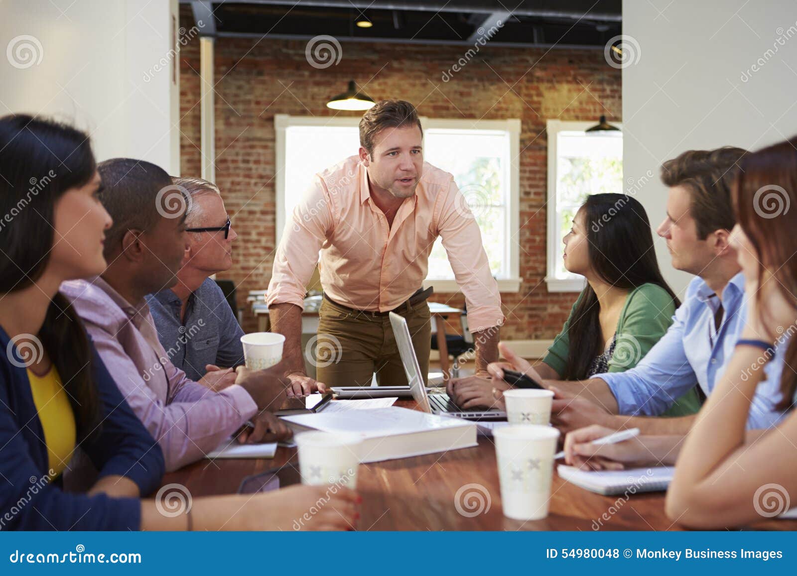 Male Boss Addressing Office Workers at Meeting Stock Photo - Image of ...
