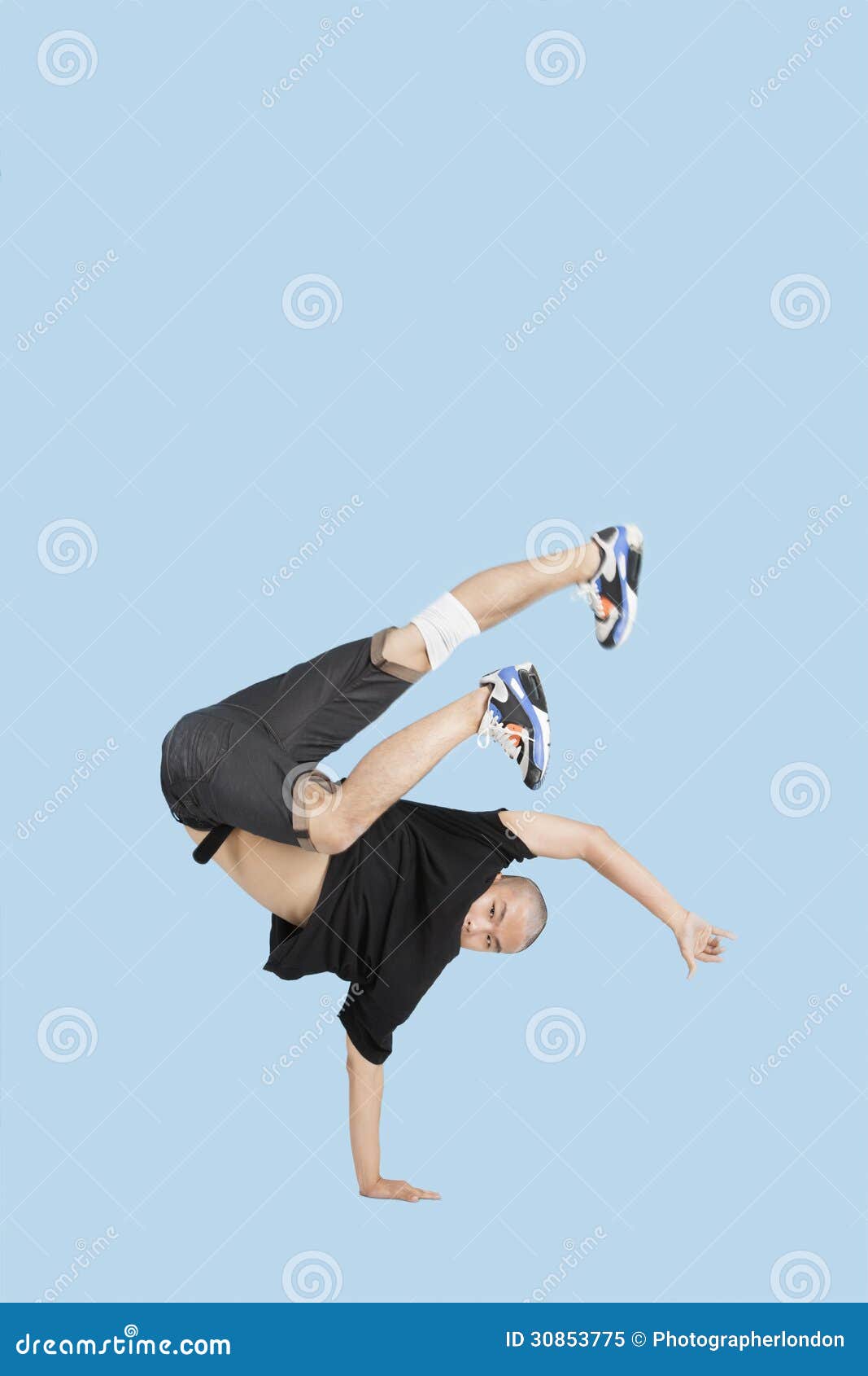 Male Break Dancer Performing Handstand Over Blue Background Stock Image ...
