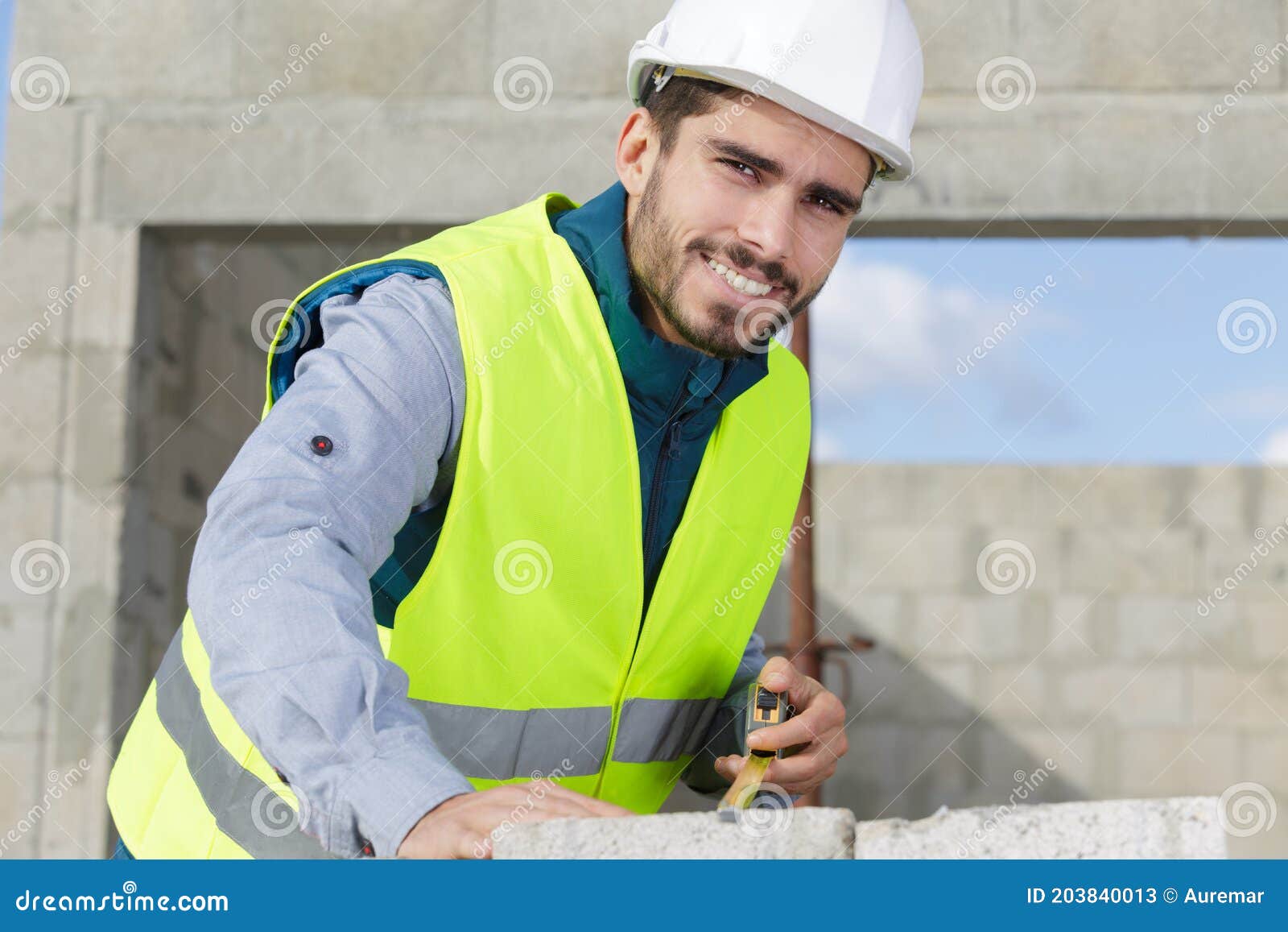 Male Bricklayer Using Measuring Tape Stock Image - Image of coating ...