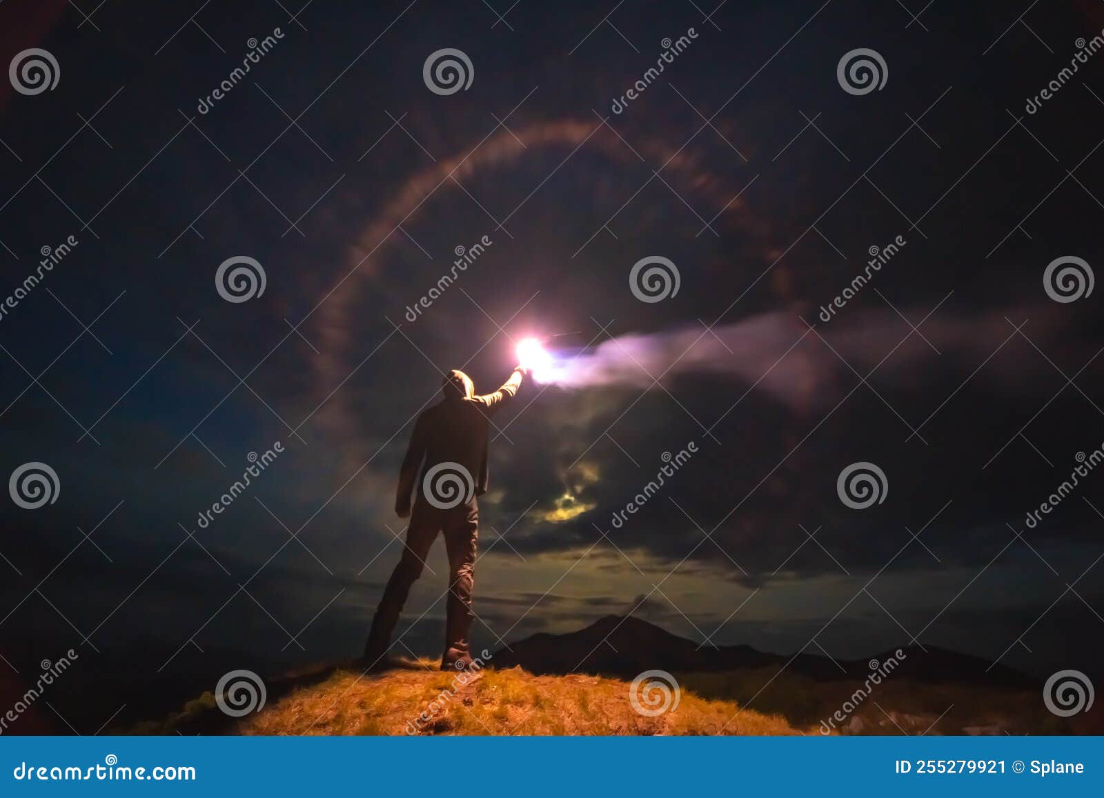The Male with a Bright Firework Stick Standing on a Mountain. Evening ...