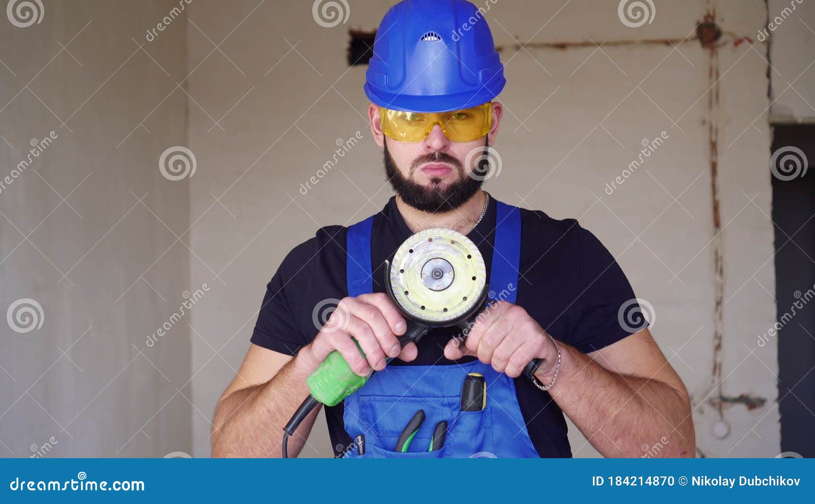Male Builder with Angle Grinder. Portrait of a Worker at a Construction ...