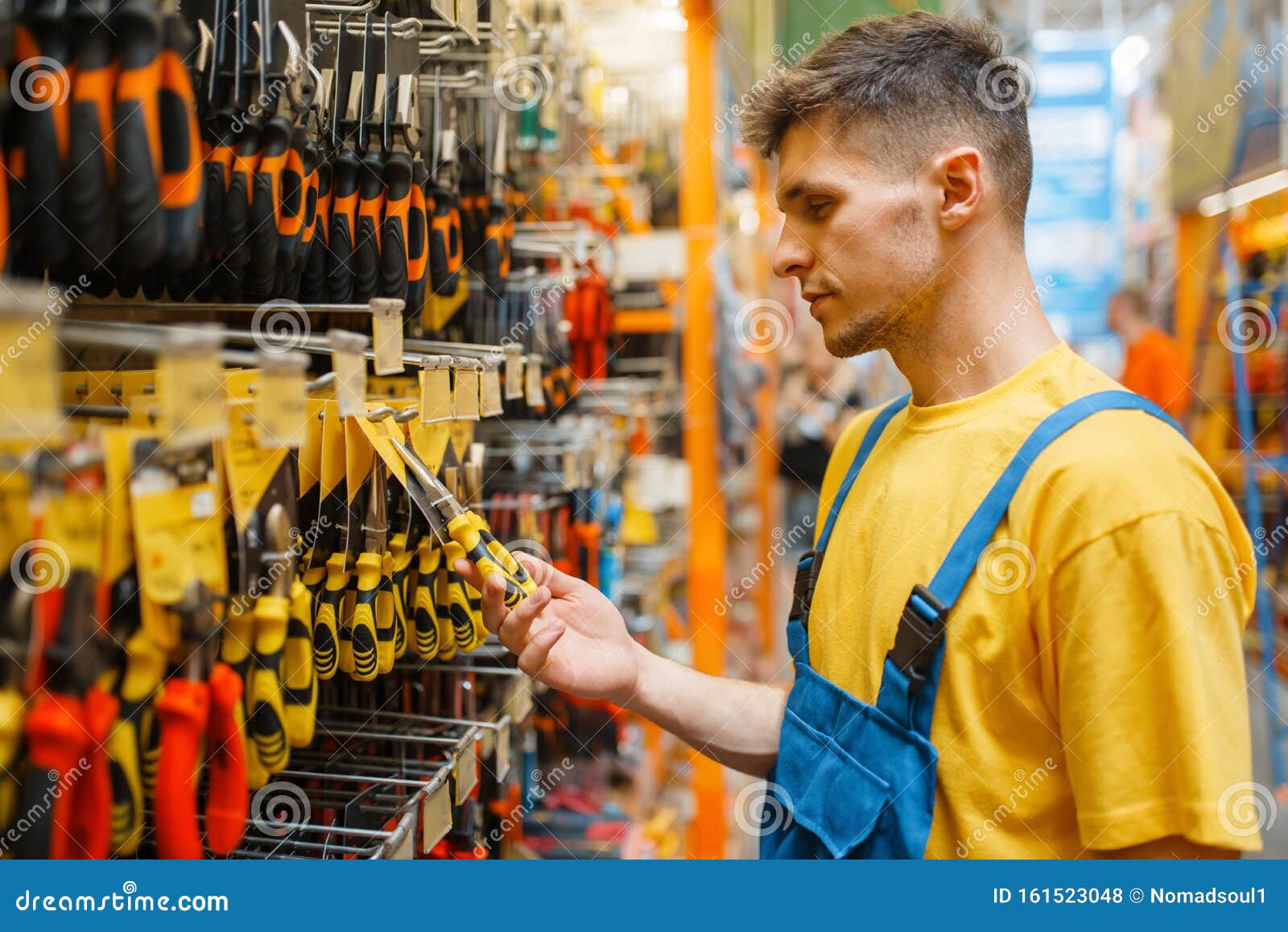 Male Builder Choosing Pliers in Hardware Store Stock Photo - Image of ...