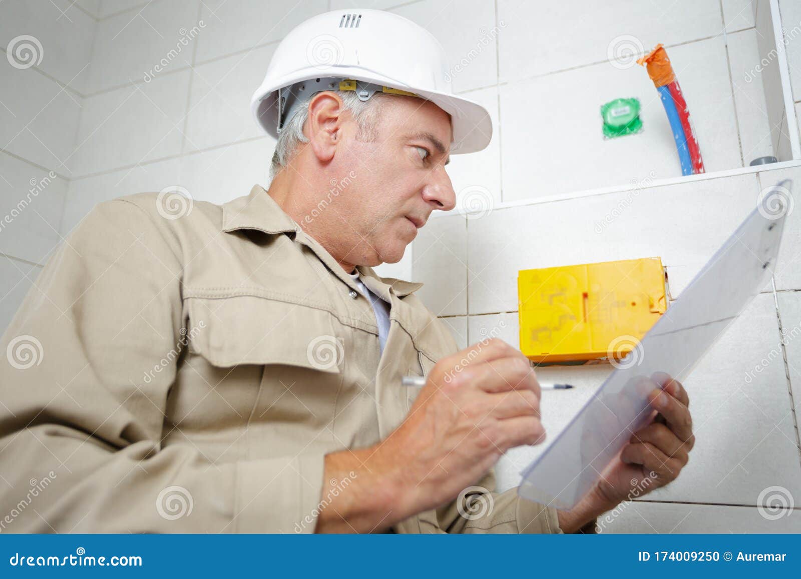 Male Builder Drilling Holes in Wall at Construction Site Stock Photo ...