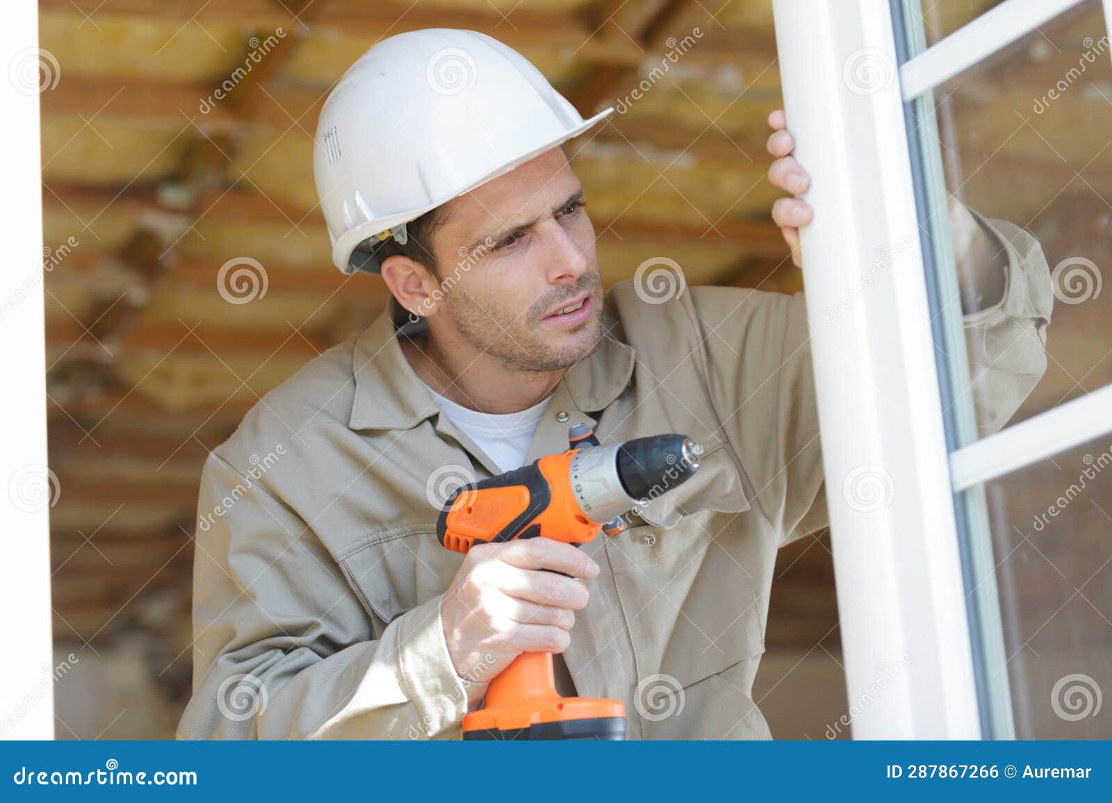 Male Builder Drilling Holes in Wall at Construction Site Stock Photo ...