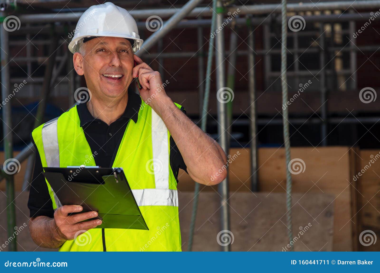 Male Builder Foreman Architect Contractor on Building Site Using Phone ...