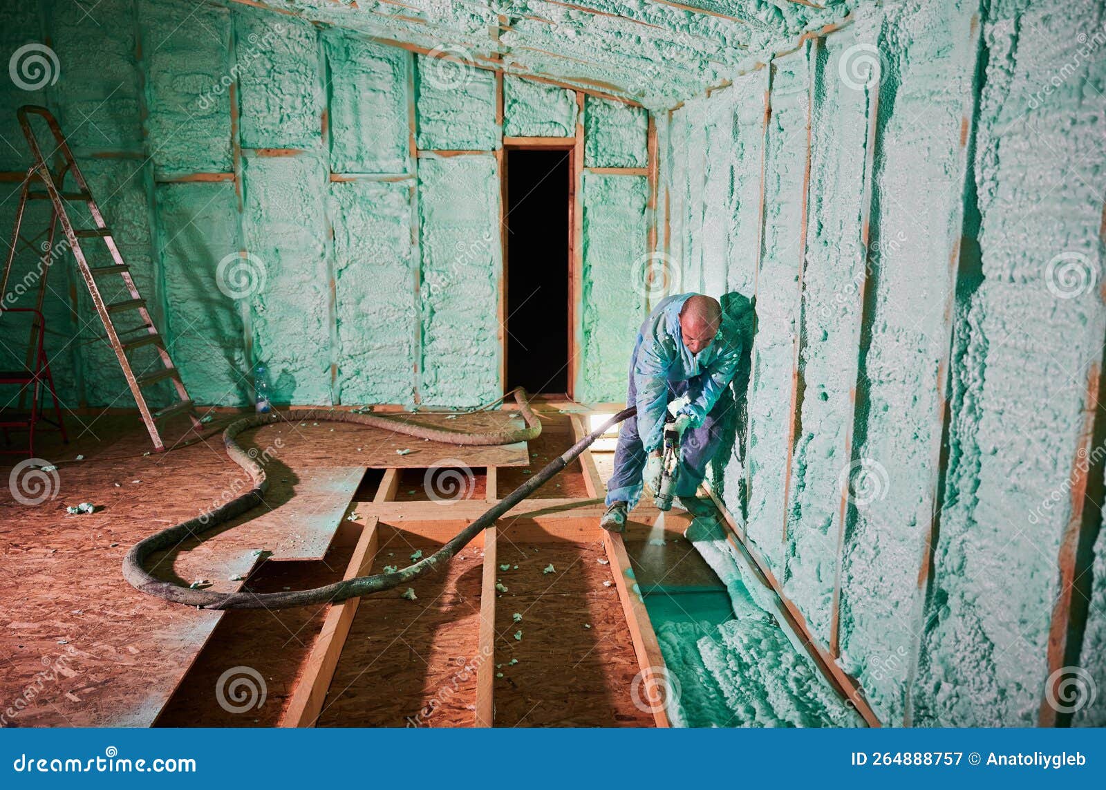 Worker Spraying Polyurethane Foam for Insulating Wooden Frame House ...