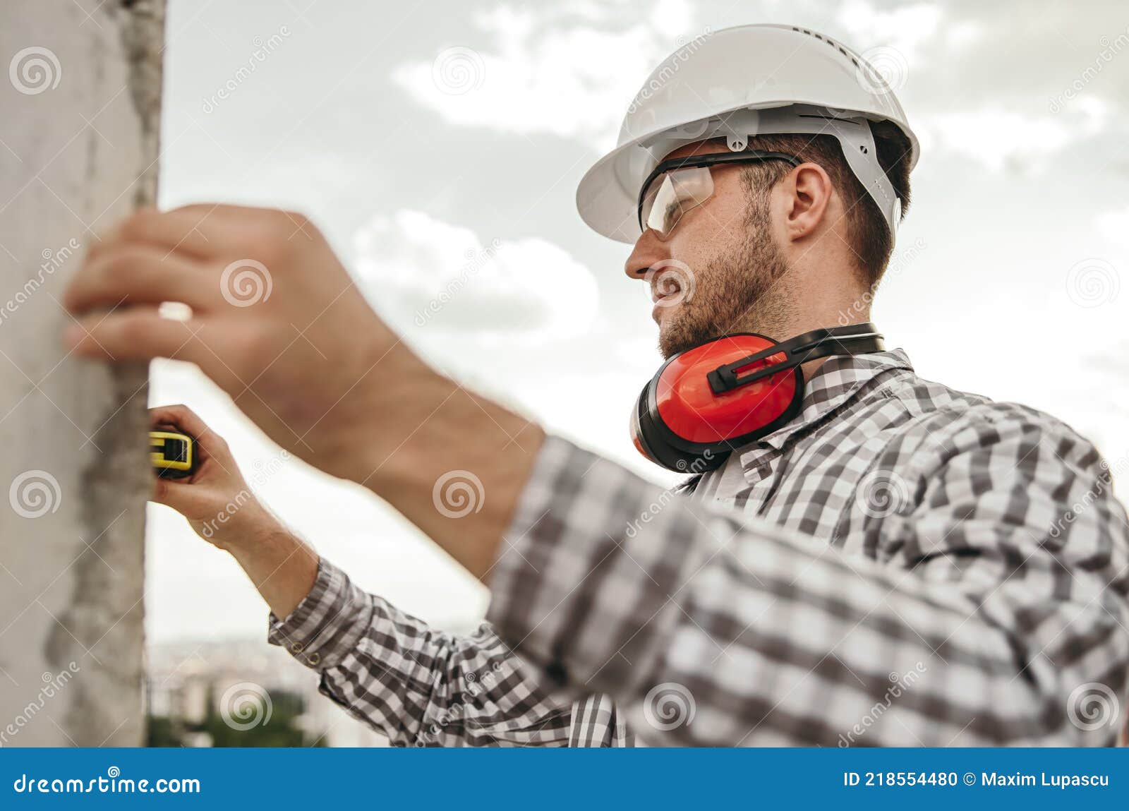 Male Builder Measuring Wall at Construction Site Stock Photo - Image of ...