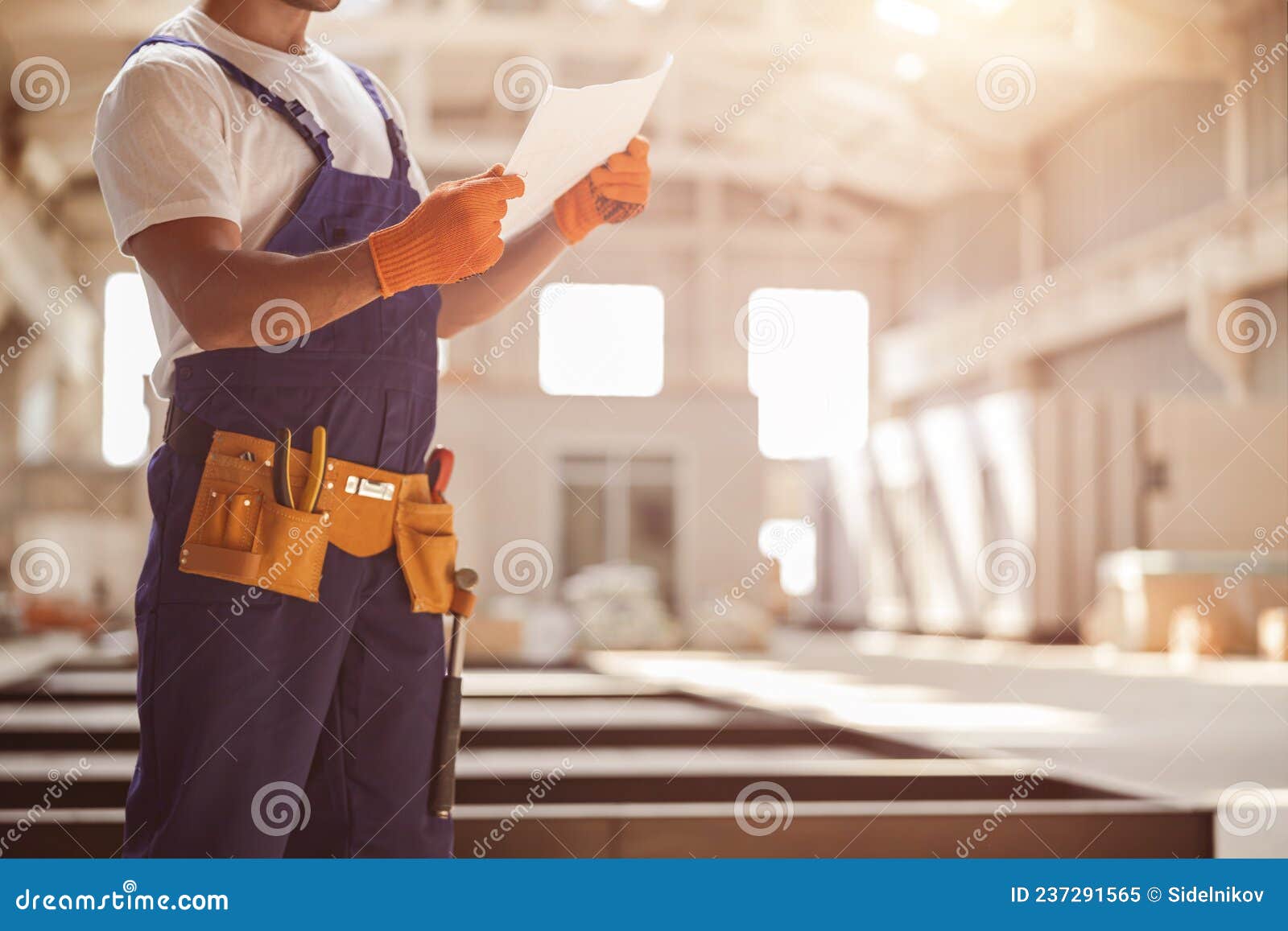 Male Builder Studying Architectural Plan at Construction Site Stock ...