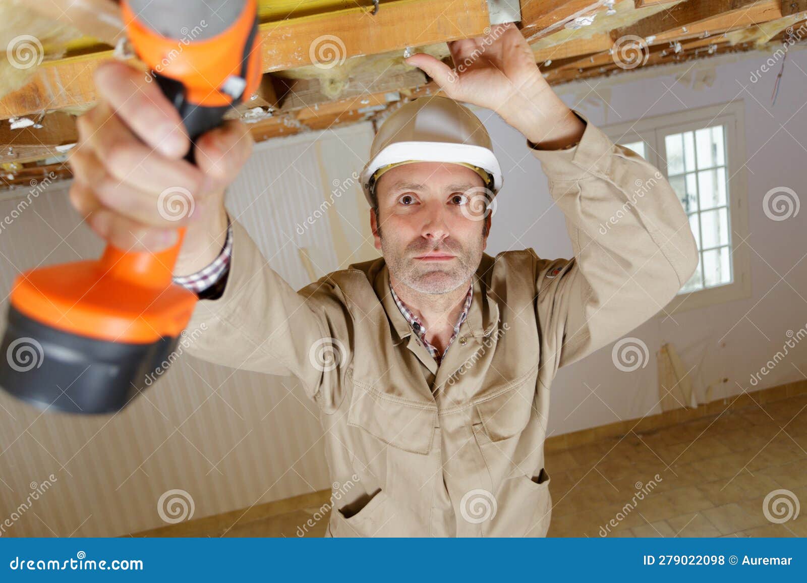 Male Builder Using Cordless Drill Overhead Stock Photo - Image of ...