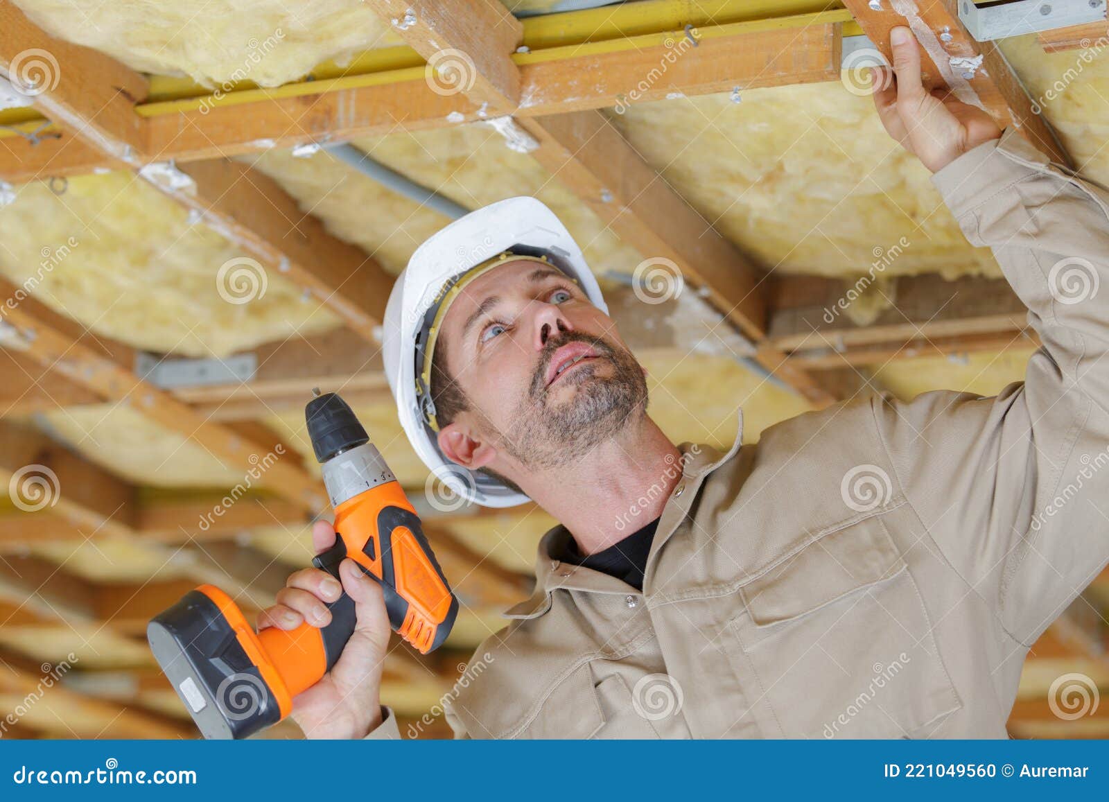Male Builder Using Drill on Wooden Ceiling Framework Stock Photo ...