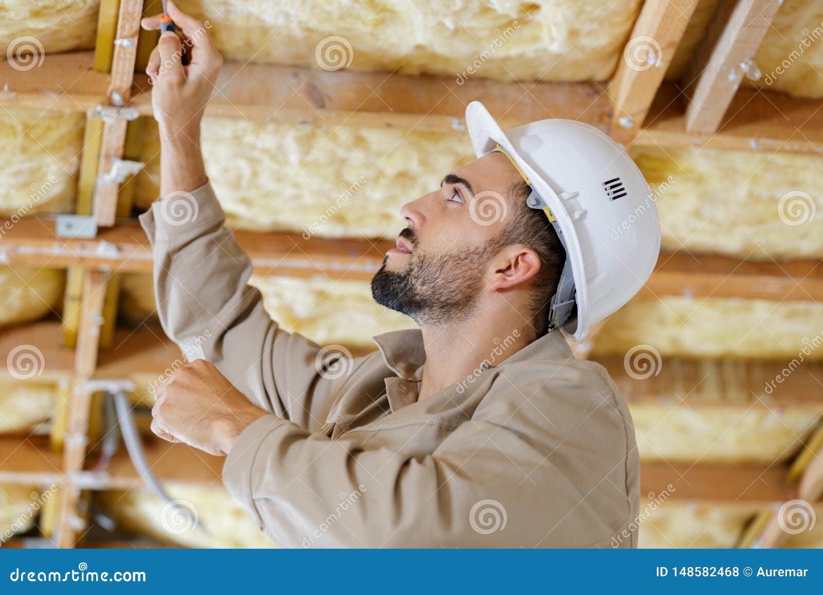 Male Builder Using Tool on Overhead Roof Timbers Stock Photo - Image of ...