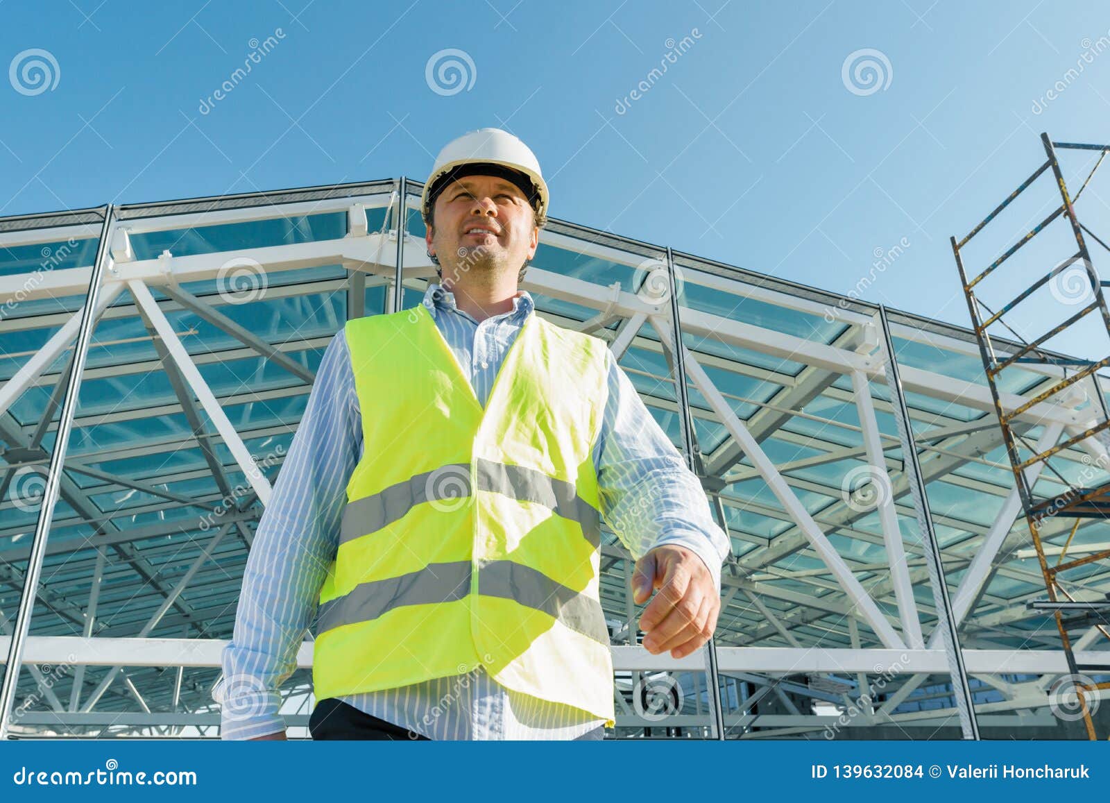 Male Builder Walking Forward on the Roof of Construction Site. Building ...