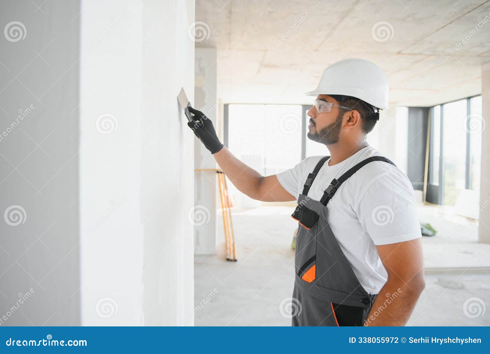 Indian Male Builder in Work Overalls Plastering a Wall Using a ...