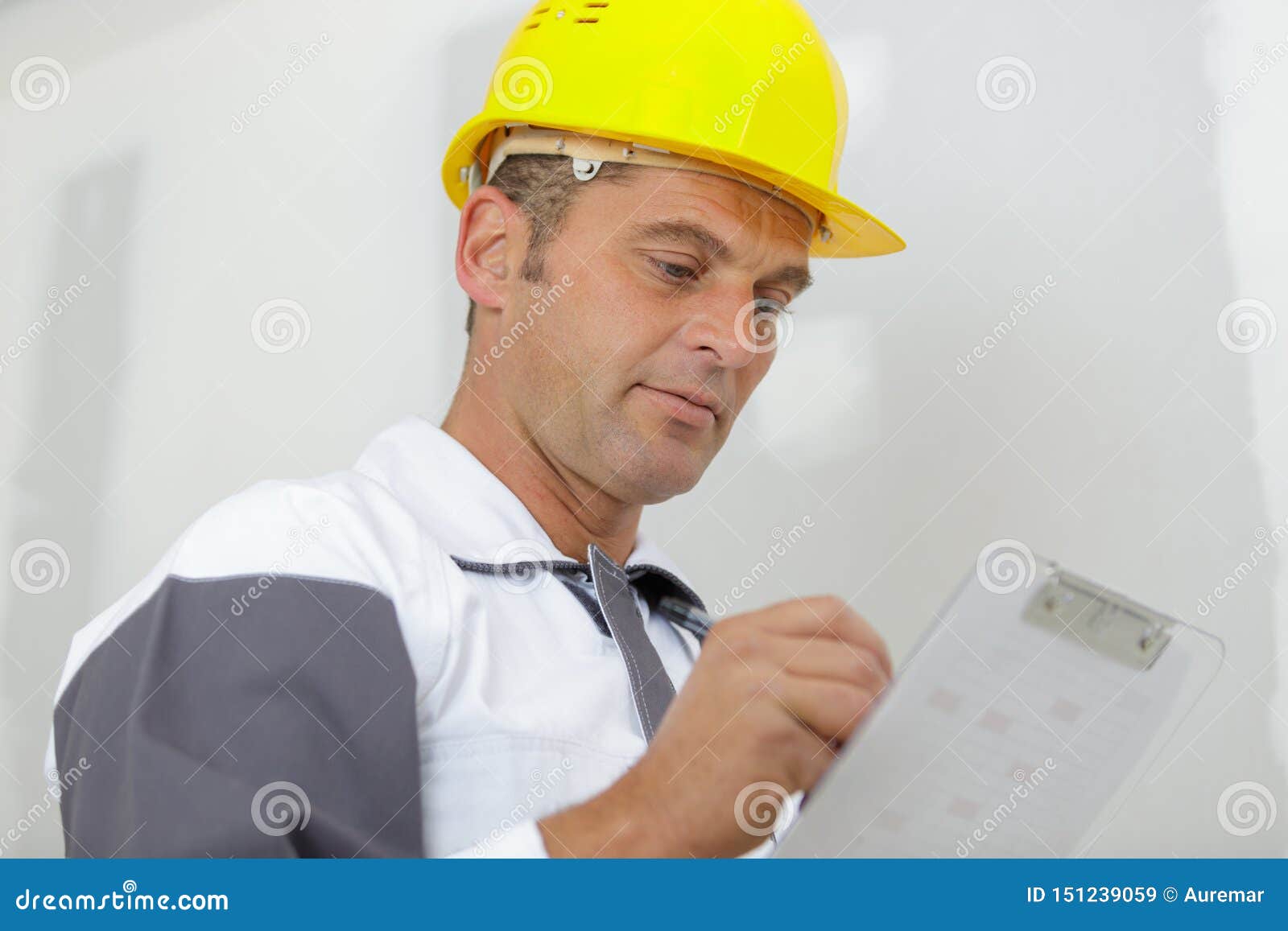 Male Builder Writing on Clipboard Stock Image - Image of builder ...
