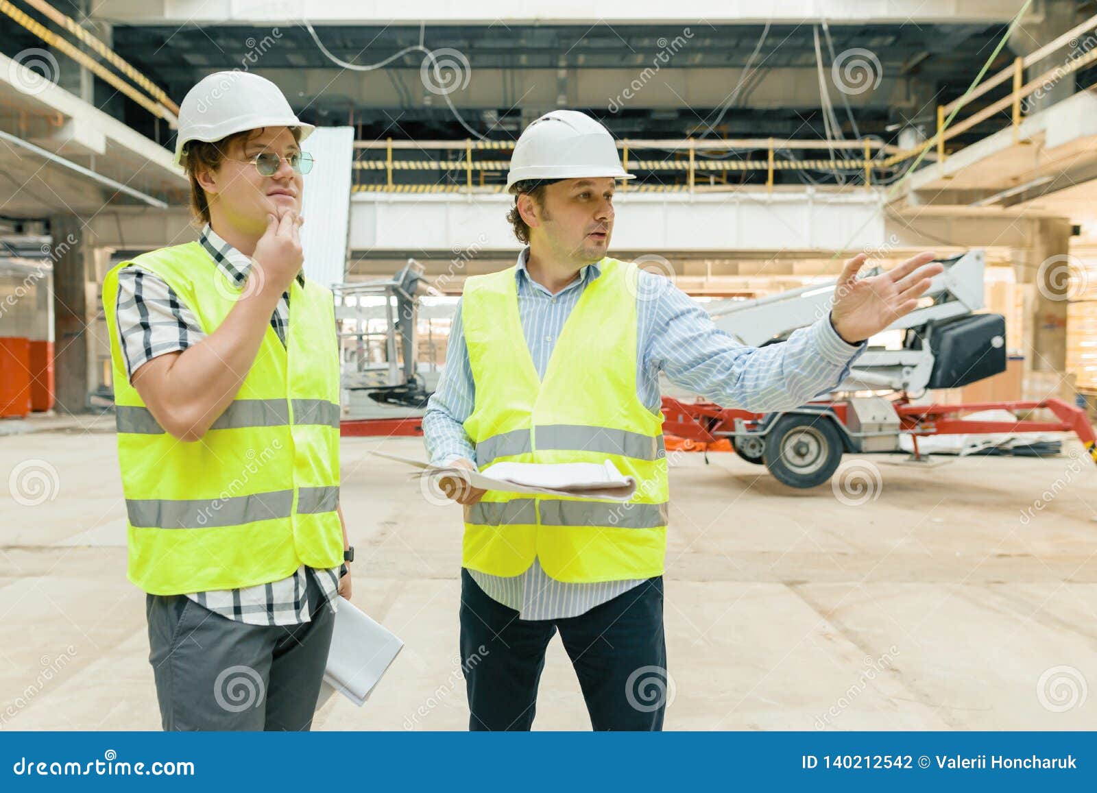 Male Building Workers Working At Construction Site. Building ...