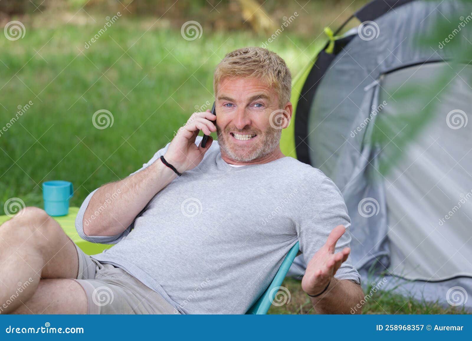Male Camper Talking on Cellphone Outside Tent Stock Image - Image of ...