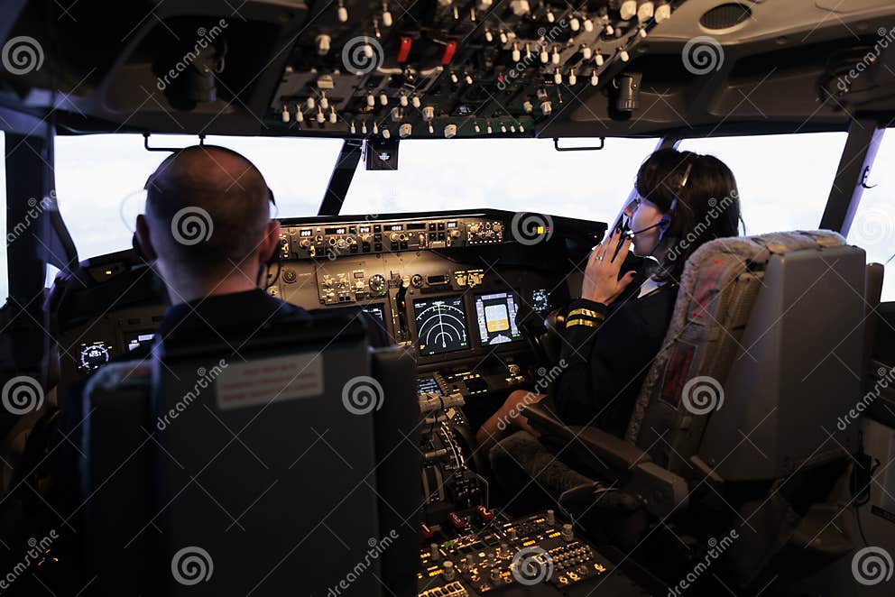 Male Captain and Copilot Flying Airplane with Control Command Stock ...