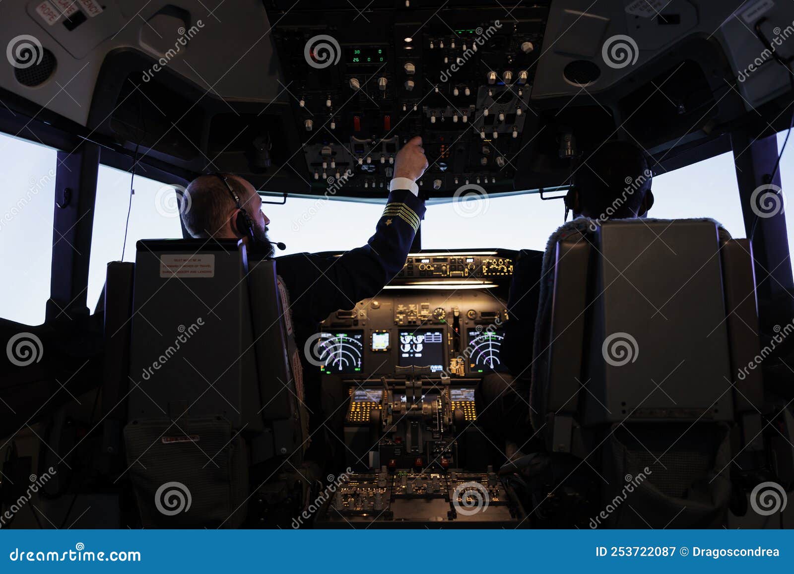 Male Captain Using Control Panel In Cockpit To Fly Airborne Aircraft ...