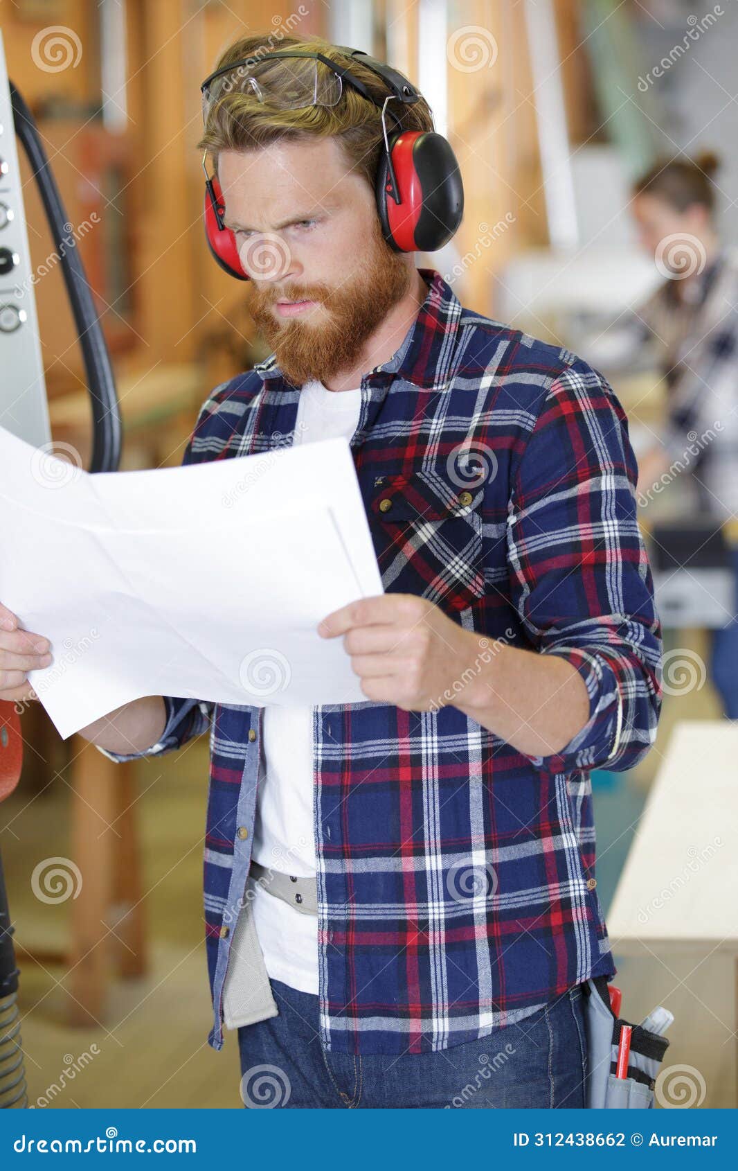 Male Carpenter with Ear Protector Looking at Map Stock Photo - Image of ...
