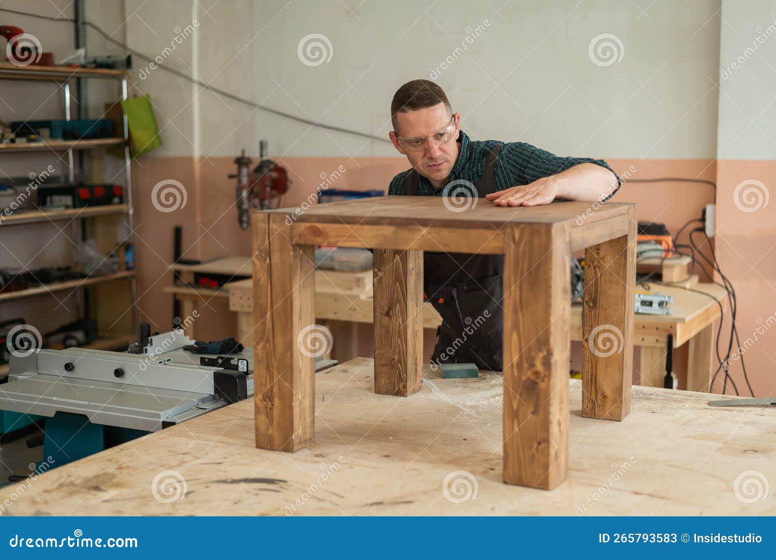 Male Carpenter Finishing Work on Wooden Table in Workshop. Stock Image ...