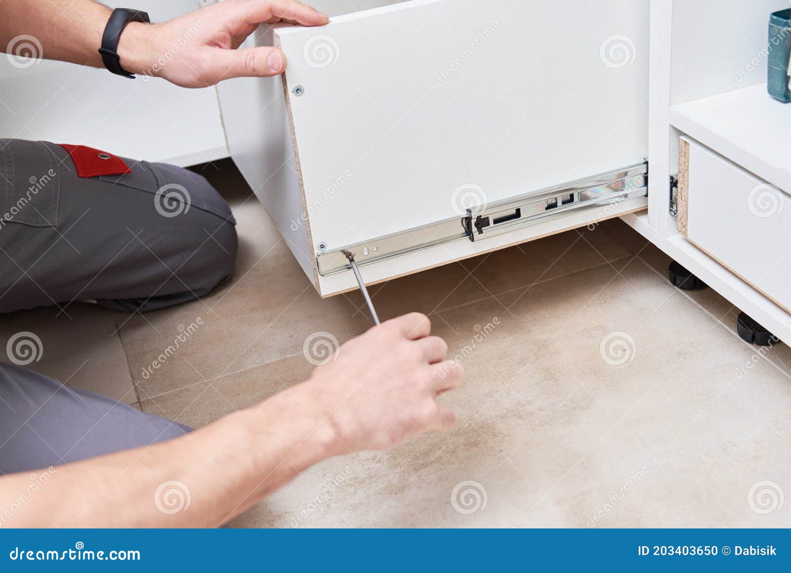 Male Carpenter Install Shelf in Kitchen Cabinet Stock Photo - Image of ...