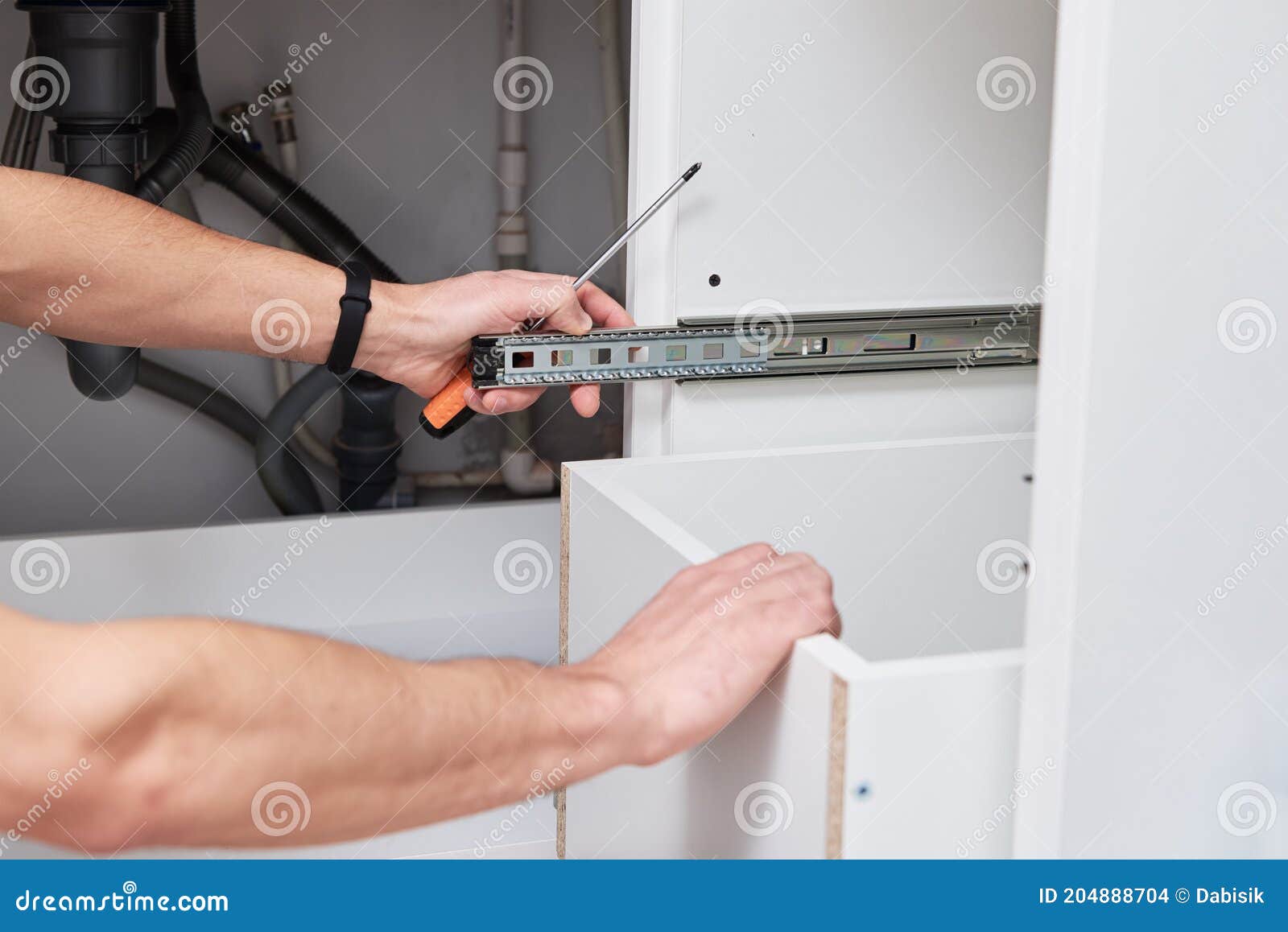 Male Carpenter Install Shelf in Kitchen Cabinet Stock Photo - Image of ...