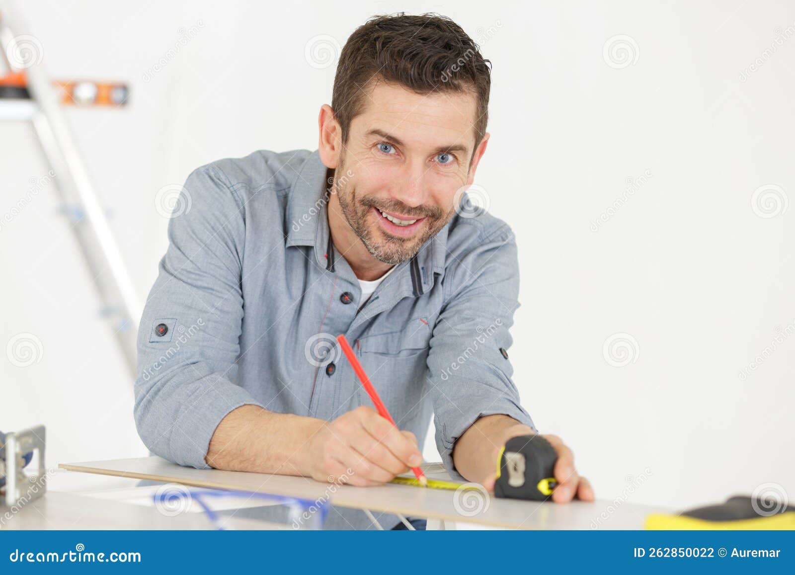 Male Carpenter Measuring and Marking Wood in Workshop Stock Photo ...