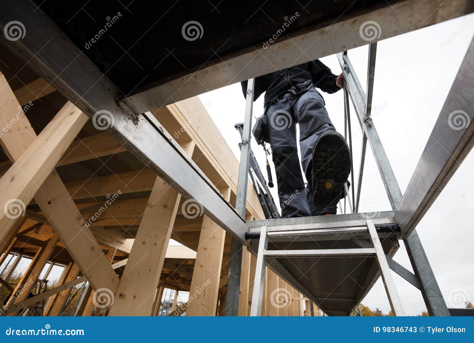 Male Carpenter Moving Down Ladder at Incomplete Building Stock Image ...
