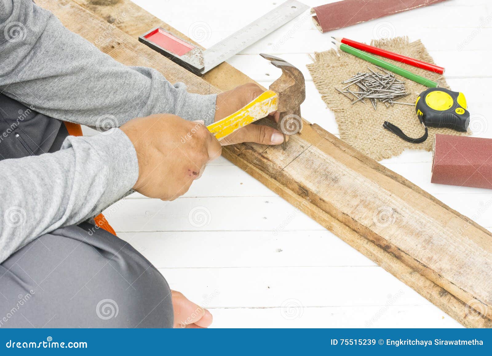 Male Carpenter Using Hammer and Nail at Work Place.Background Craftsman ...