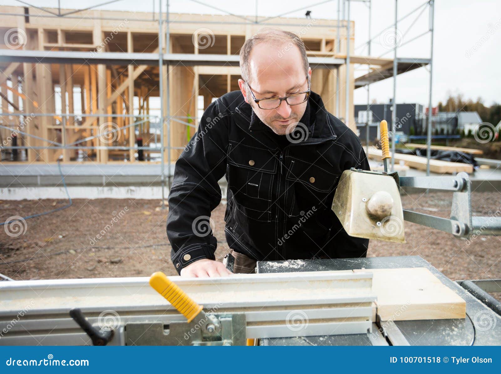 Carpenter Using Table Saw To Cut Plank at Site Stock Photo - Image of ...