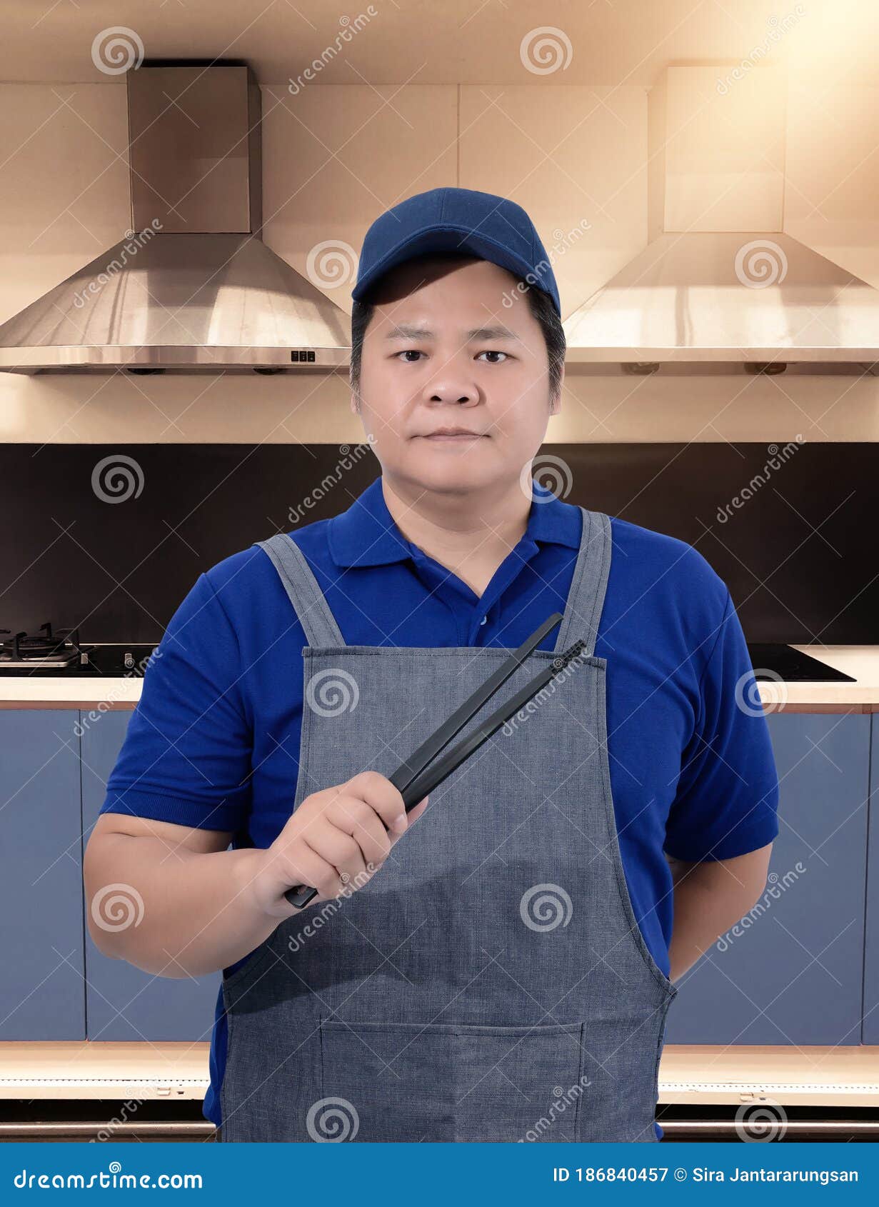 Male Chef Assistant Holding Kitchen Equipment Stock Image - Image of ...