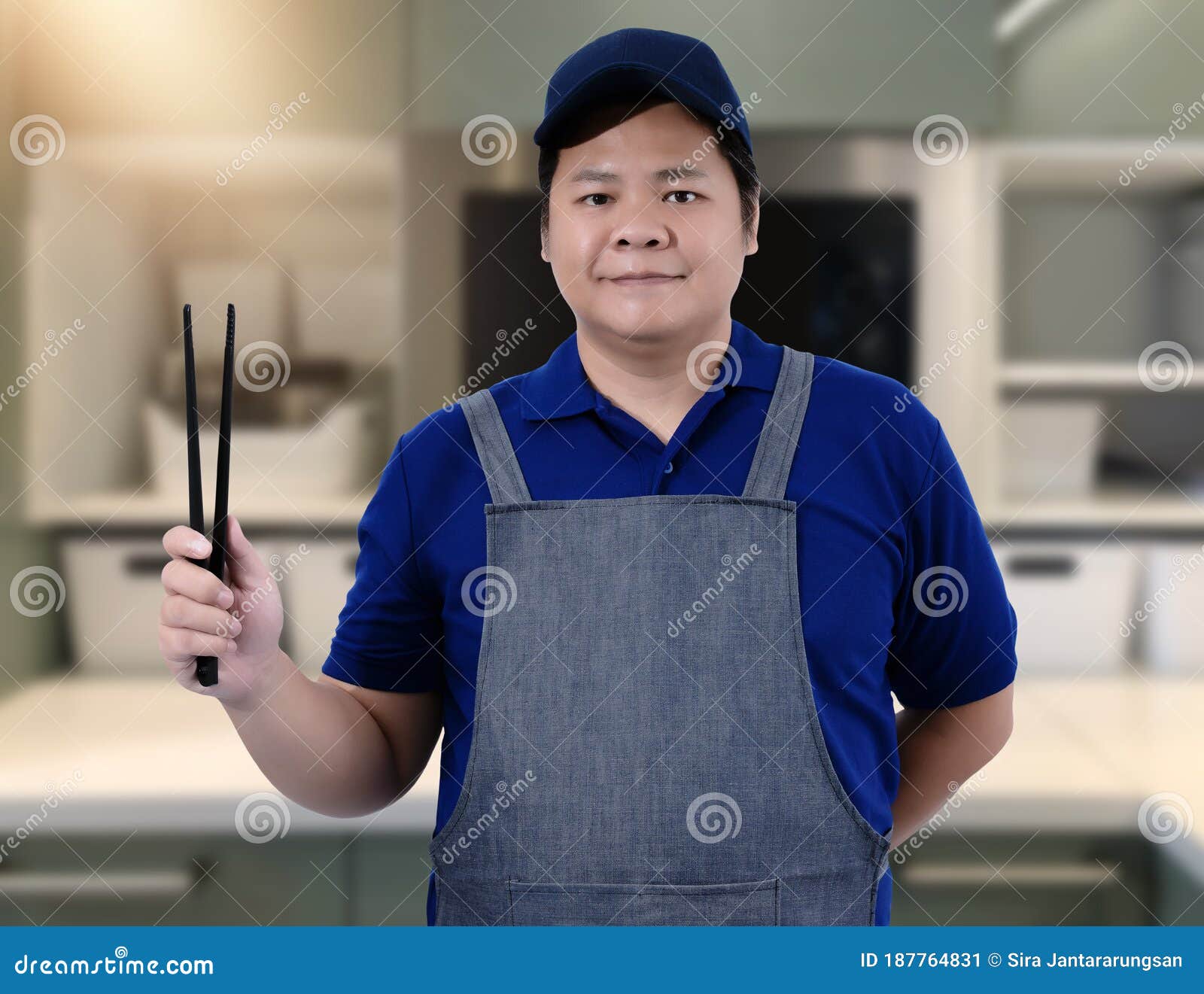 Male Chef Assistant Holding Kitchen Equipment Stock Image - Image of ...