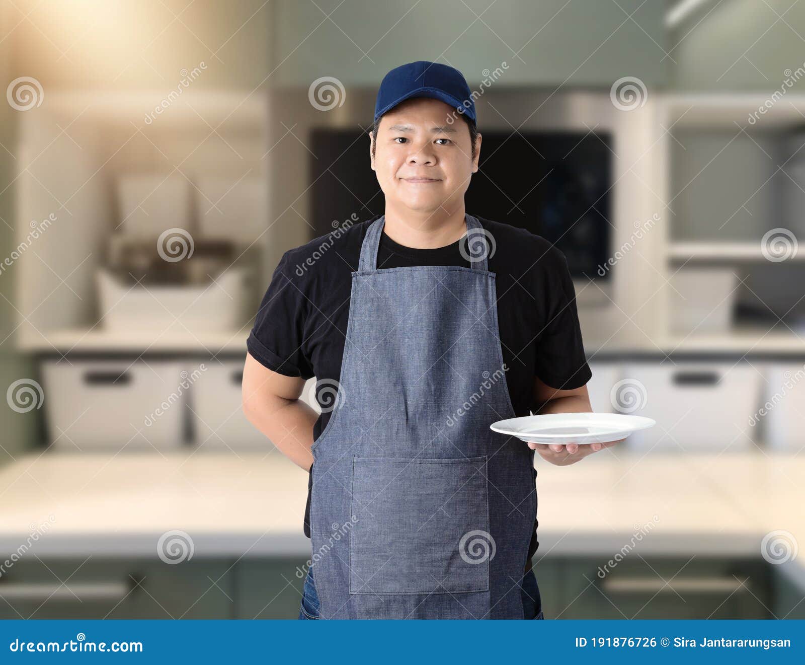 Male Chef Assistant Holding White Plate Stock Photo - Image of ...