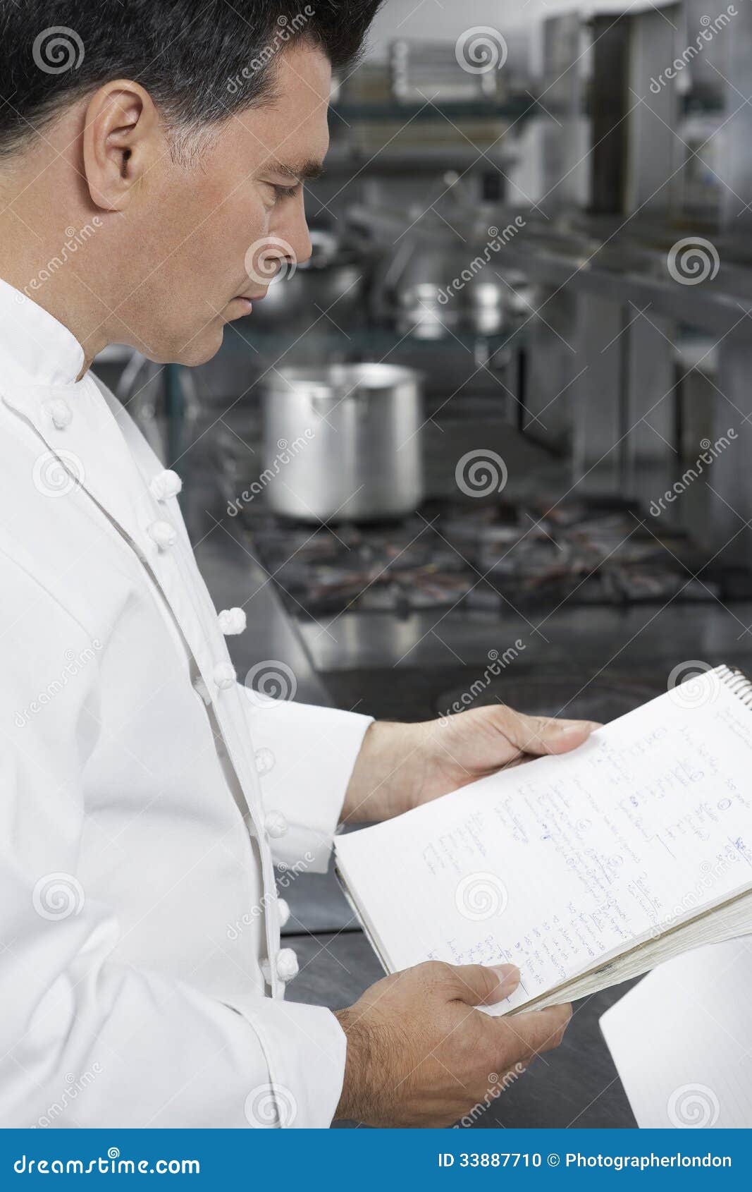 Male Chef Reading Recipe Book in Kitchen Stock Photo - Image of ...
