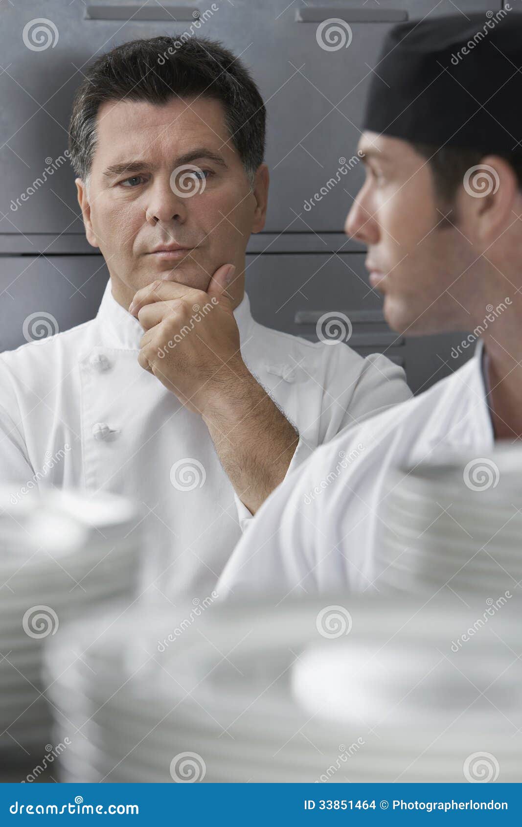 Male Chef Supervising Trainee in Kitchen Stock Photo - Image of cook ...