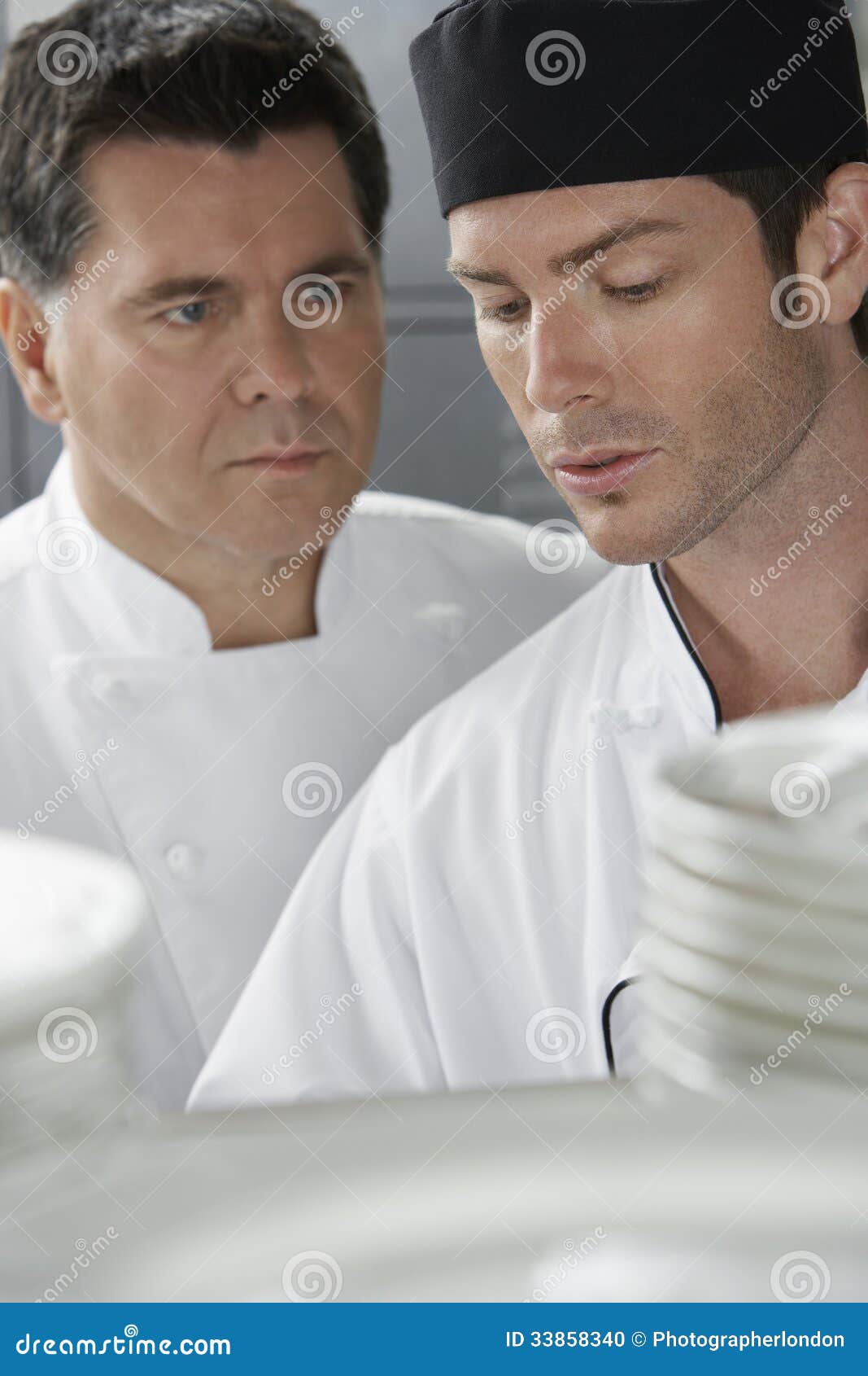 Male Chef Supervising Trainee in Kitchen Stock Photo - Image of ...