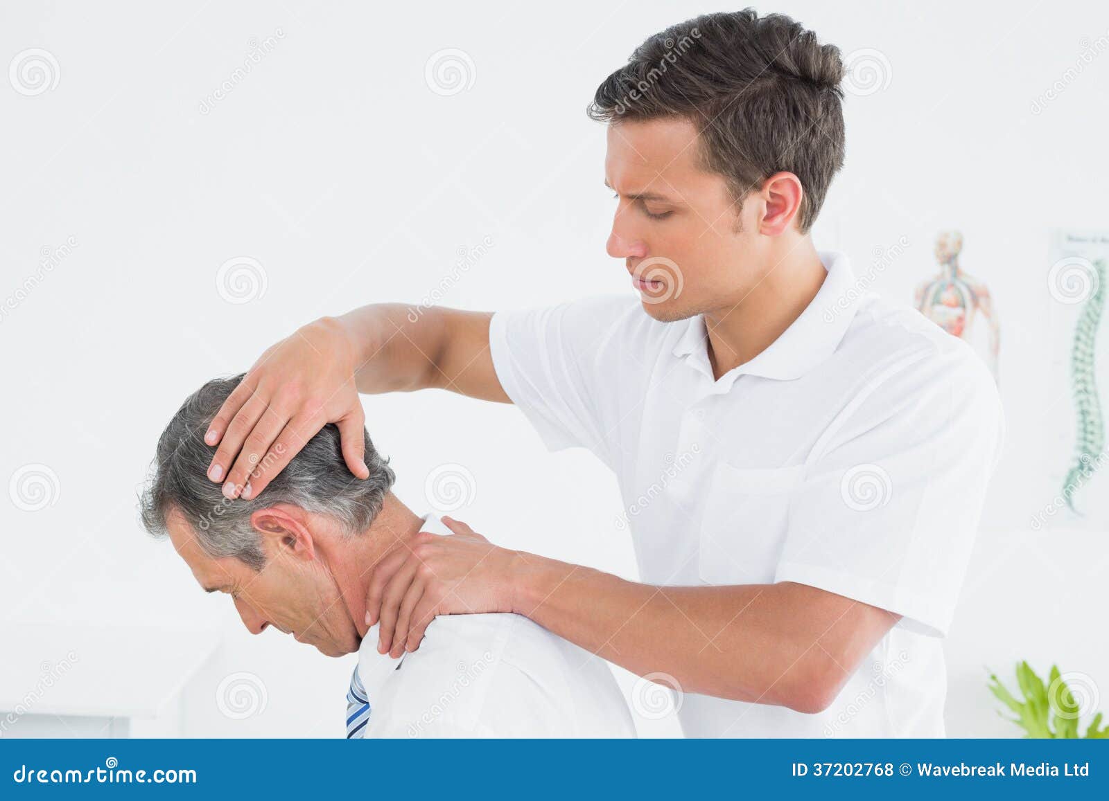 Male Chiropractor Doing Neck Adjustment Stock Photo - Image of patient ...